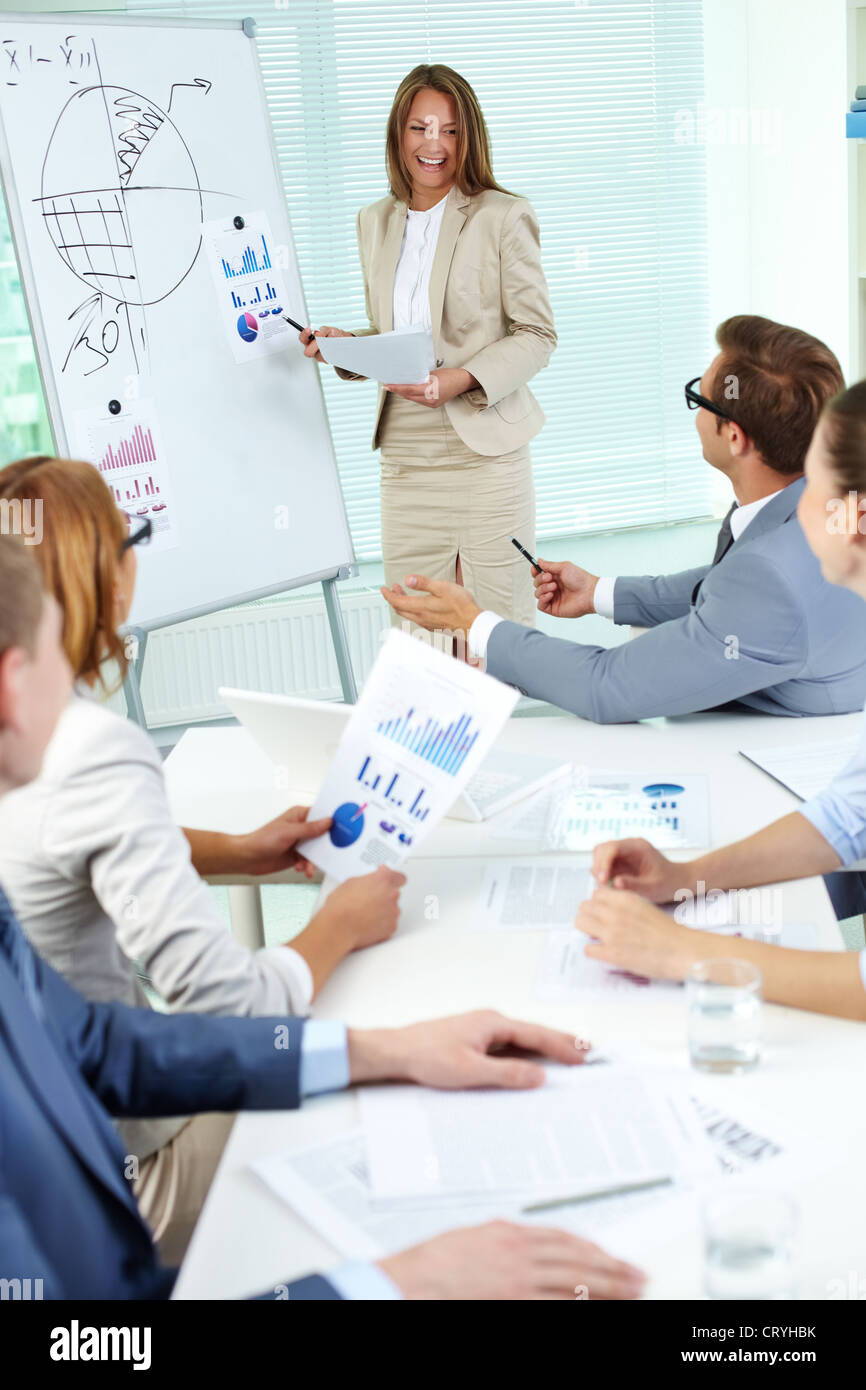 Happy top manager standing by the whiteboard and interacting with ...
