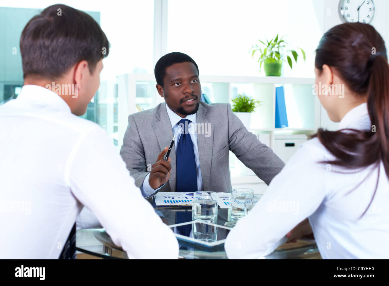 Portrait of serious boss interacting with his employees Stock Photo - Alamy