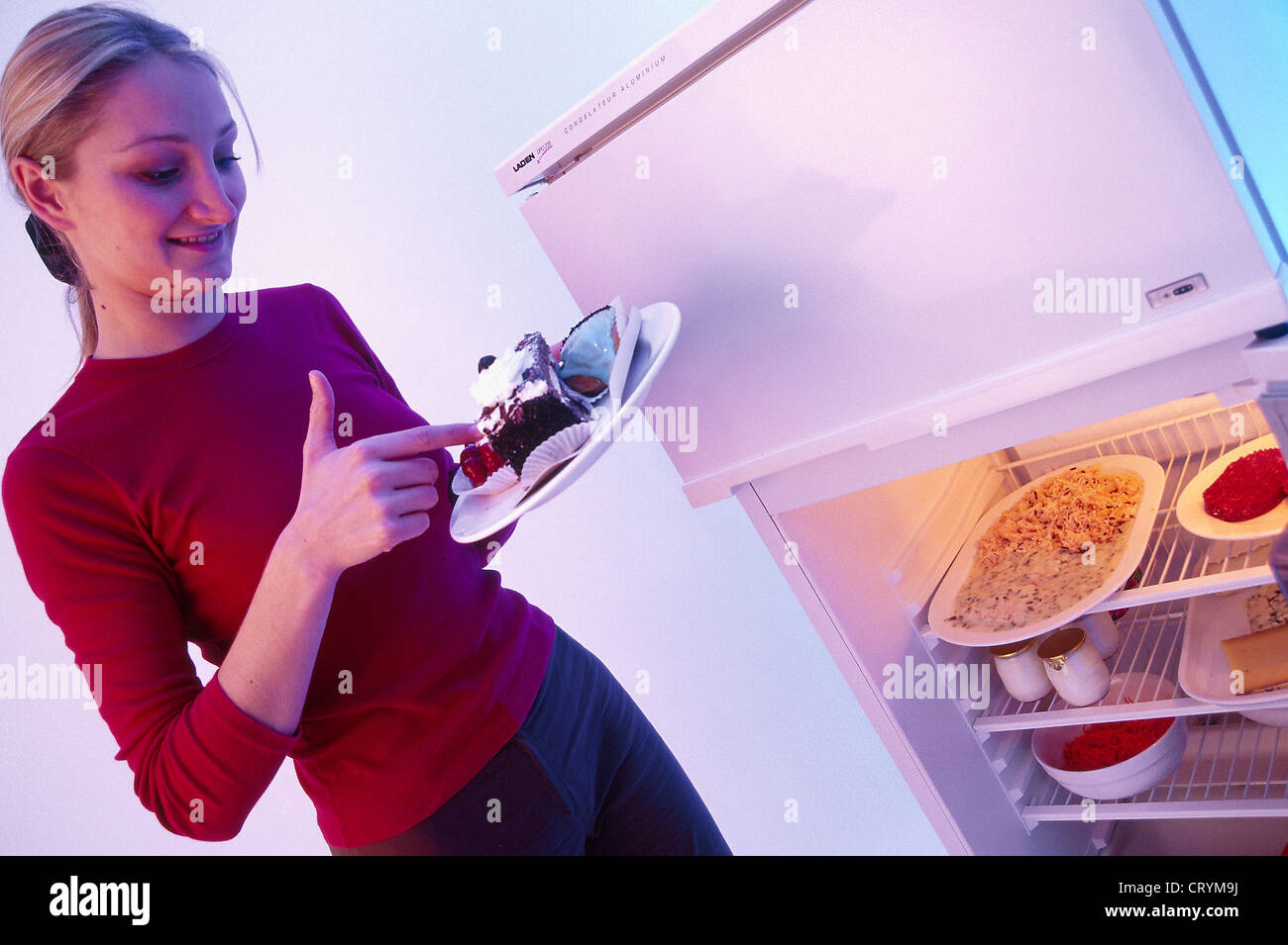 Woman binge eating kitchen hi-res stock photography and images - Alamy