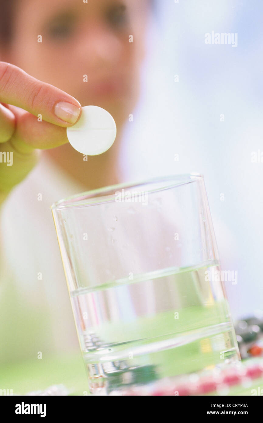 WOMAN WITH ASPIRIN Stock Photo - Alamy