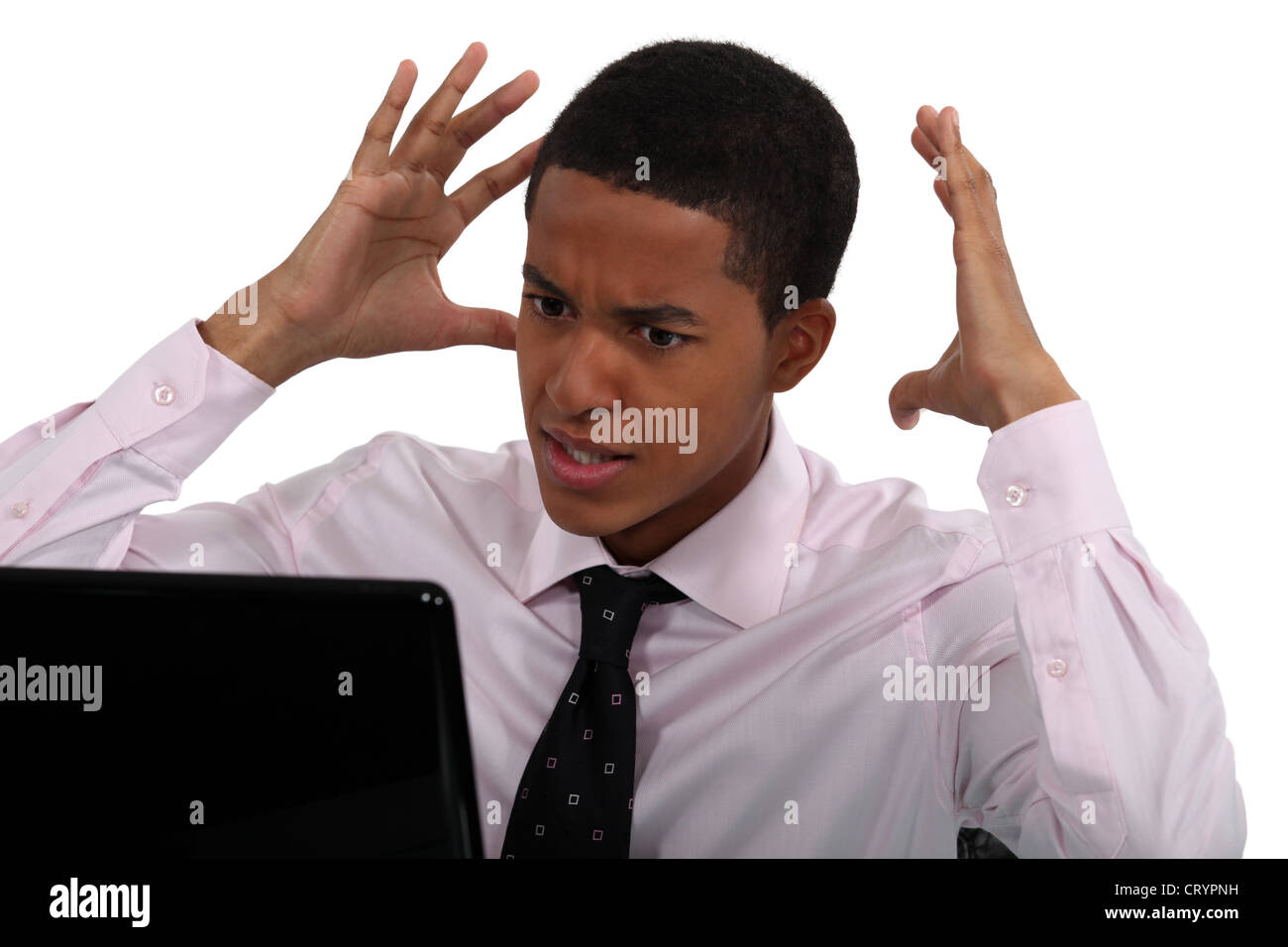 Stress young businessman sat at computer Stock Photo - Alamy