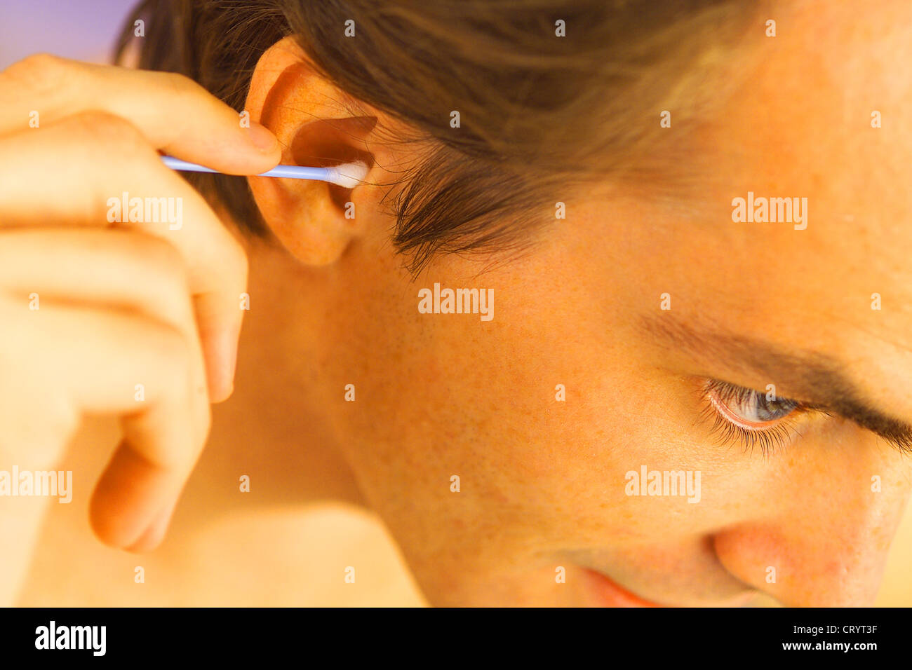 MAN CLEANING EARS Stock Photo - Alamy