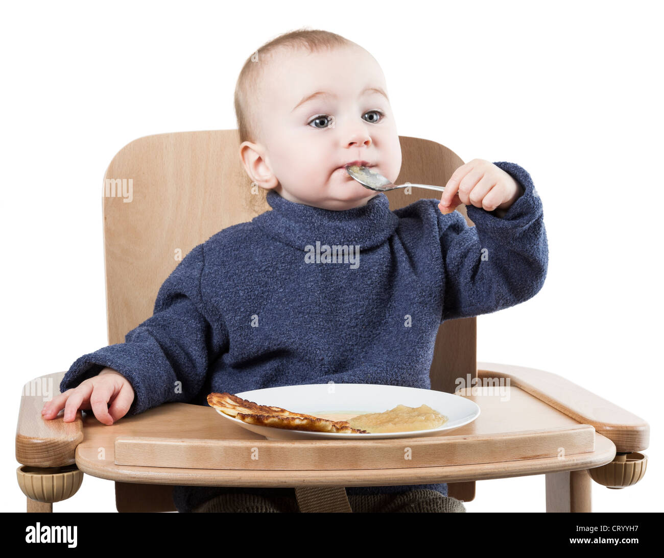 young child eating in high chair isolated in white backgound Stock ...