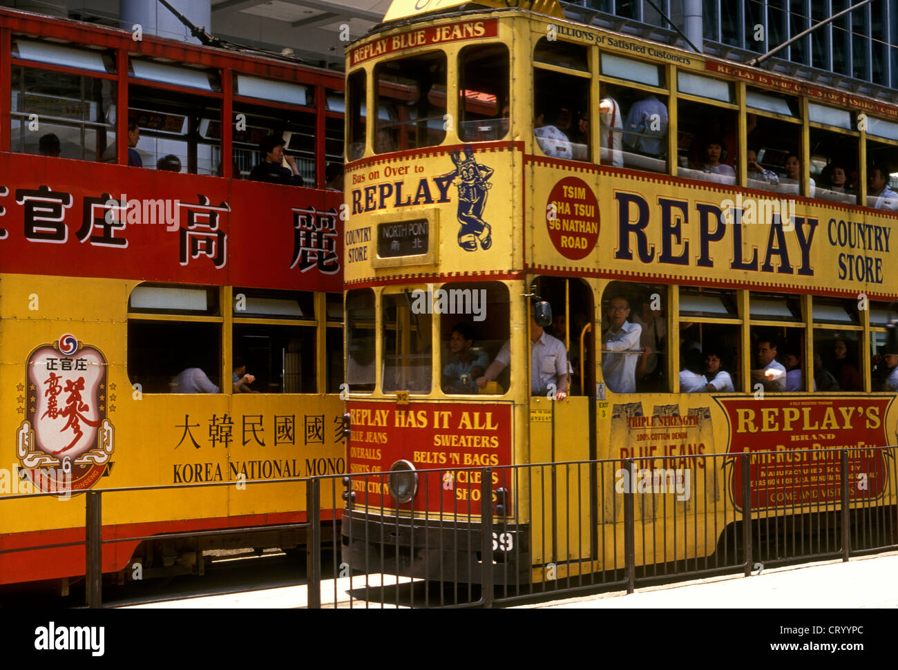passengers riding double-decker tram in Statue Square, Hong Kong Island ...