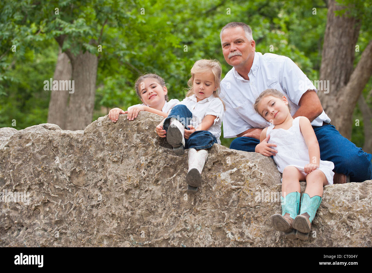Grandfather playing with his three little granddaughters Stock Photo ...