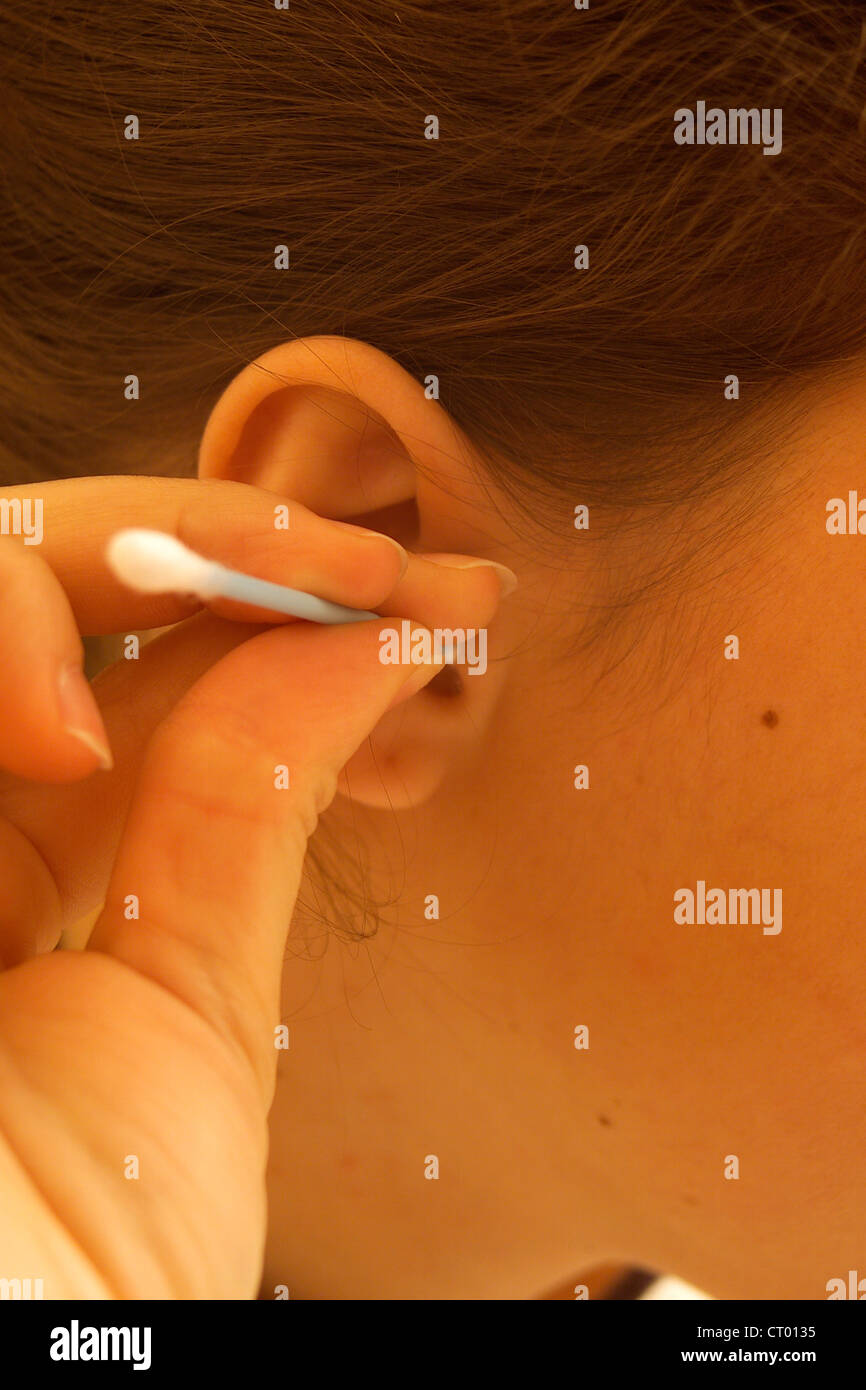 WOMAN CLEANING EARS Stock Photo - Alamy