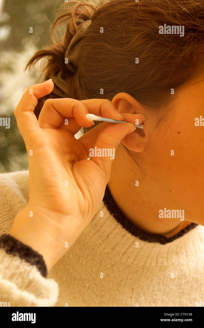 WOMAN CLEANING EARS Stock Photo - Alamy