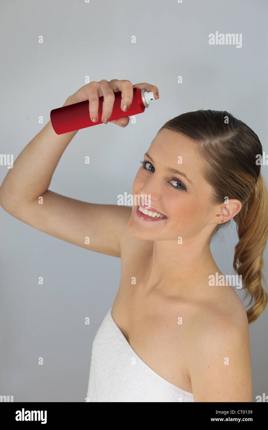 Woman using hair spray Stock Photo - Alamy