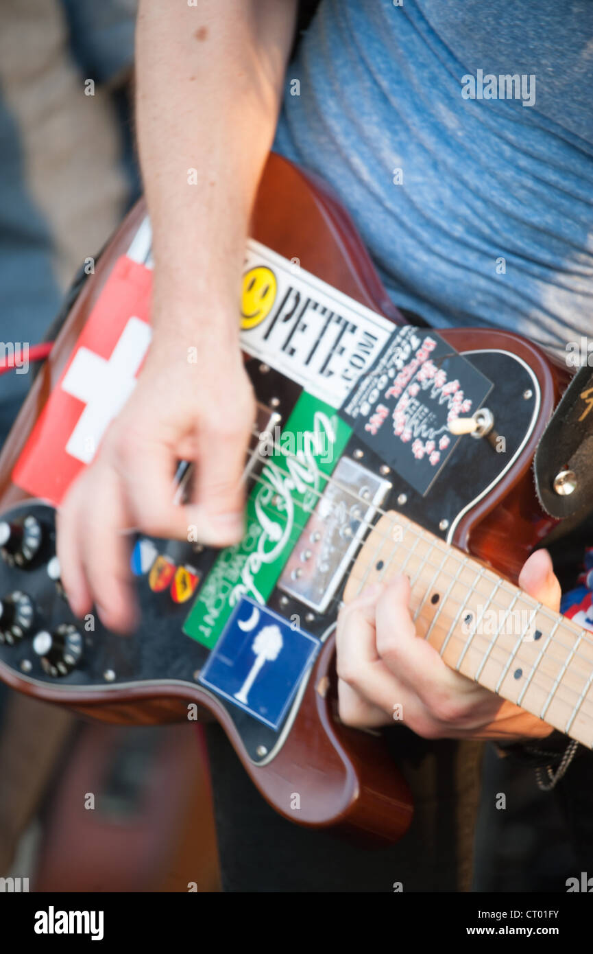 The guitarist from the band Willie Pete performs for community members ...