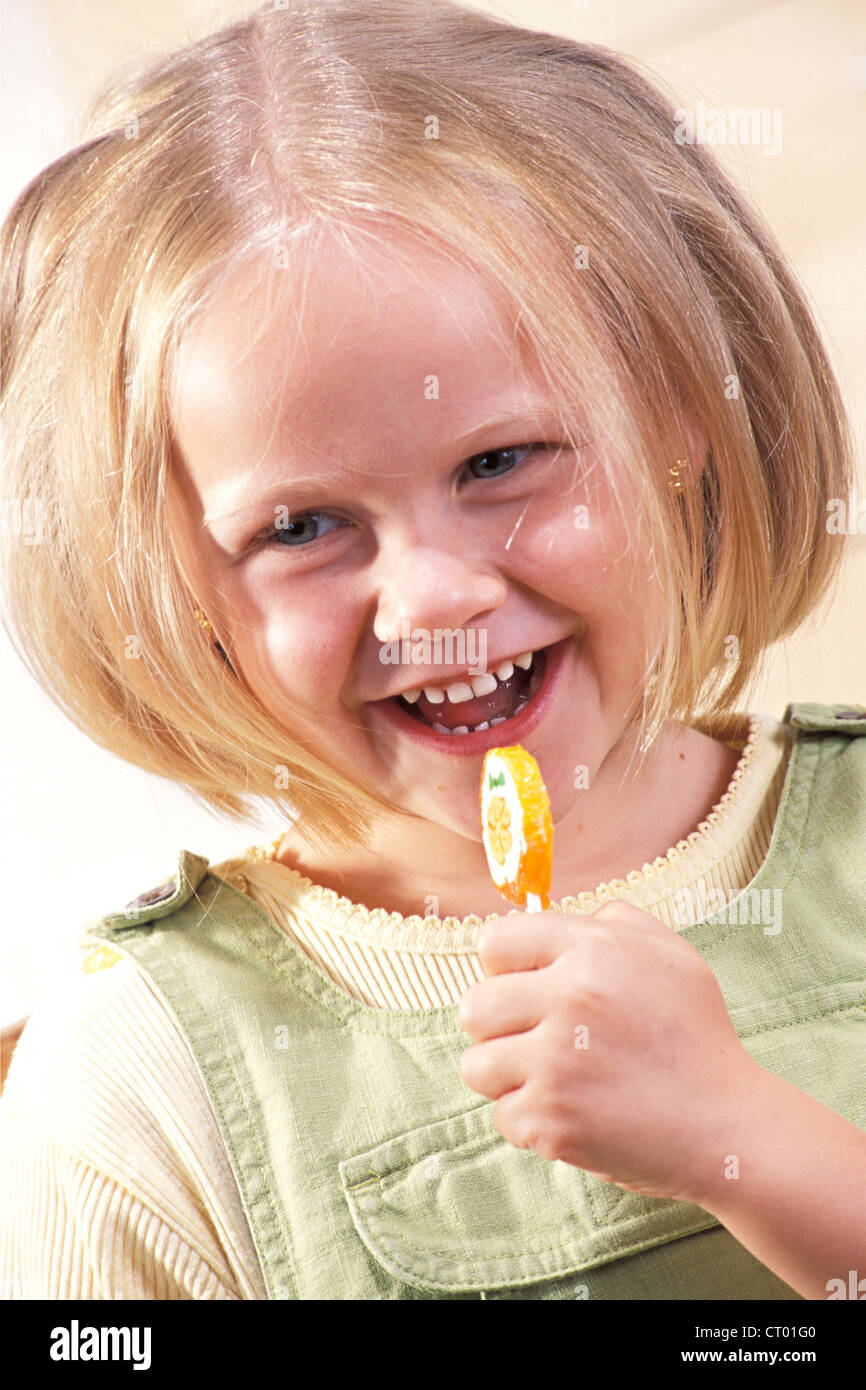 CHILD EATING SWEETS Stock Photo - Alamy