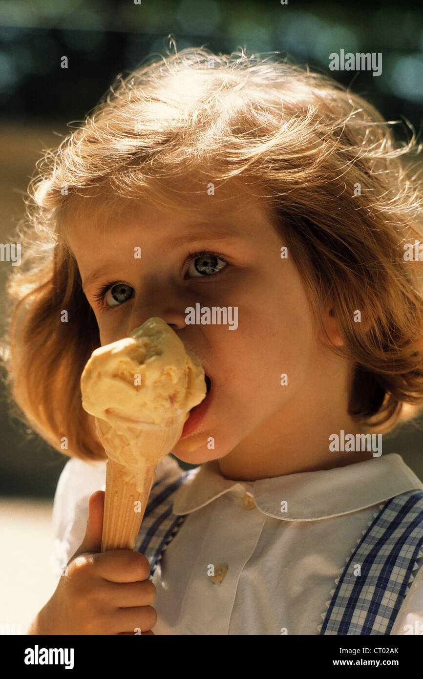 CHILD EATING SWEETS Stock Photo - Alamy