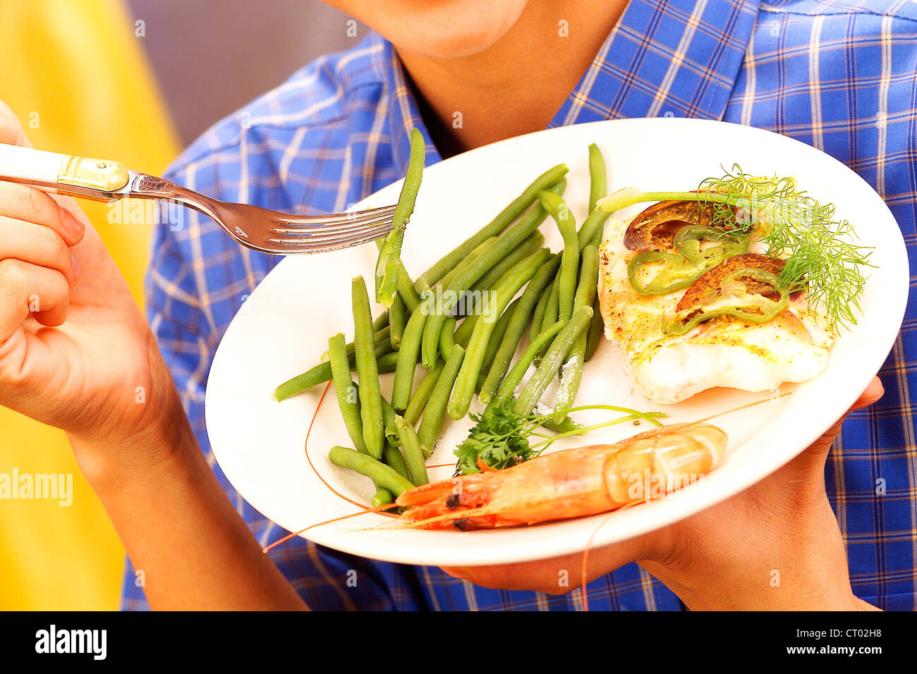 WOMAN EATING FISH Stock Photo - Alamy