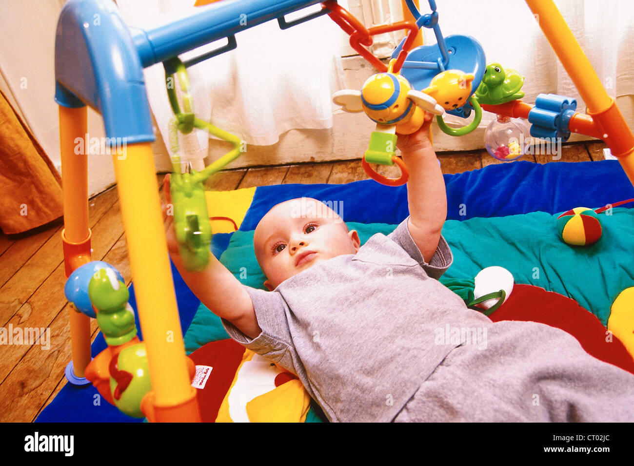 INFANT PLAYING INDOORS Stock Photo - Alamy