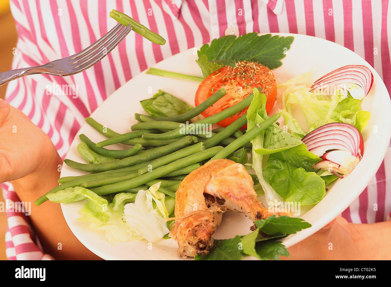 WOMAN EATING MEAT Stock Photo - Alamy