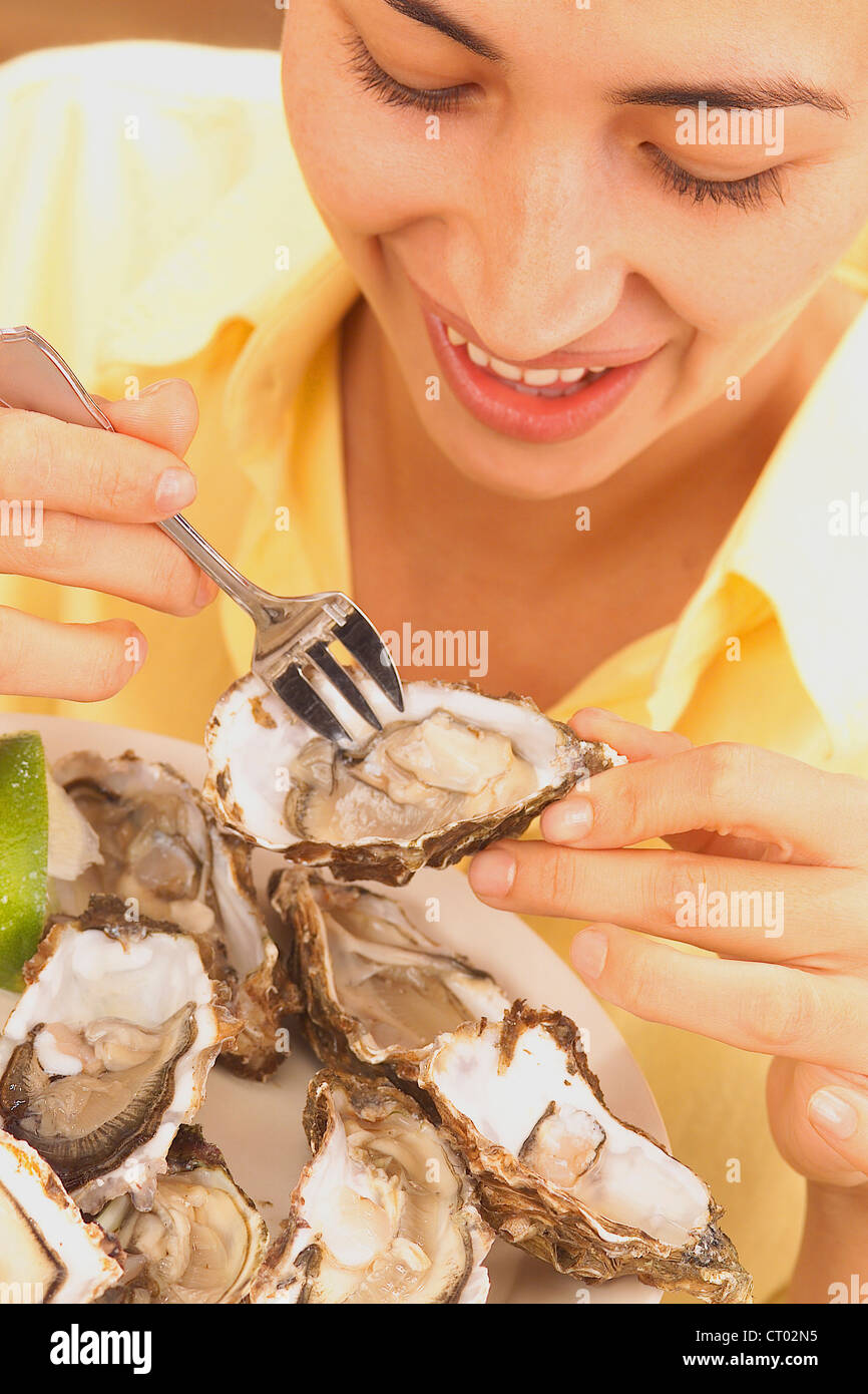 WOMAN EATING SELLFISH Stock Photo - Alamy