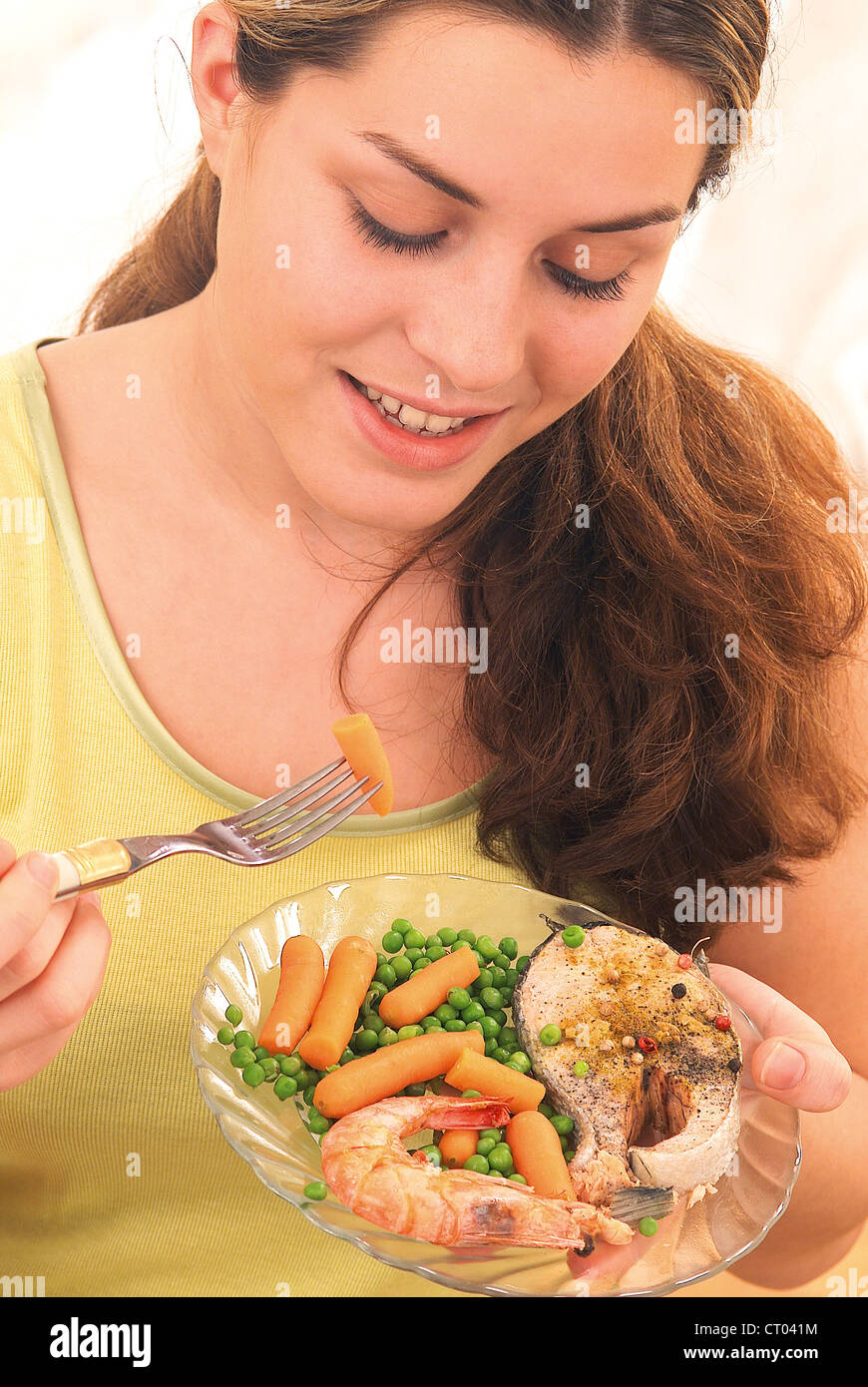 WOMAN EATING FISH Stock Photo - Alamy