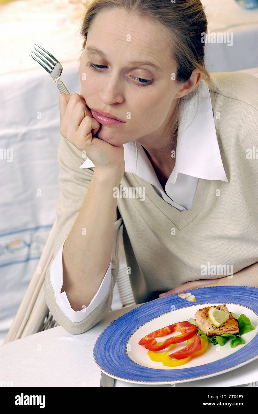 Mature woman eating fish and vegetables hi-res stock photography and ...