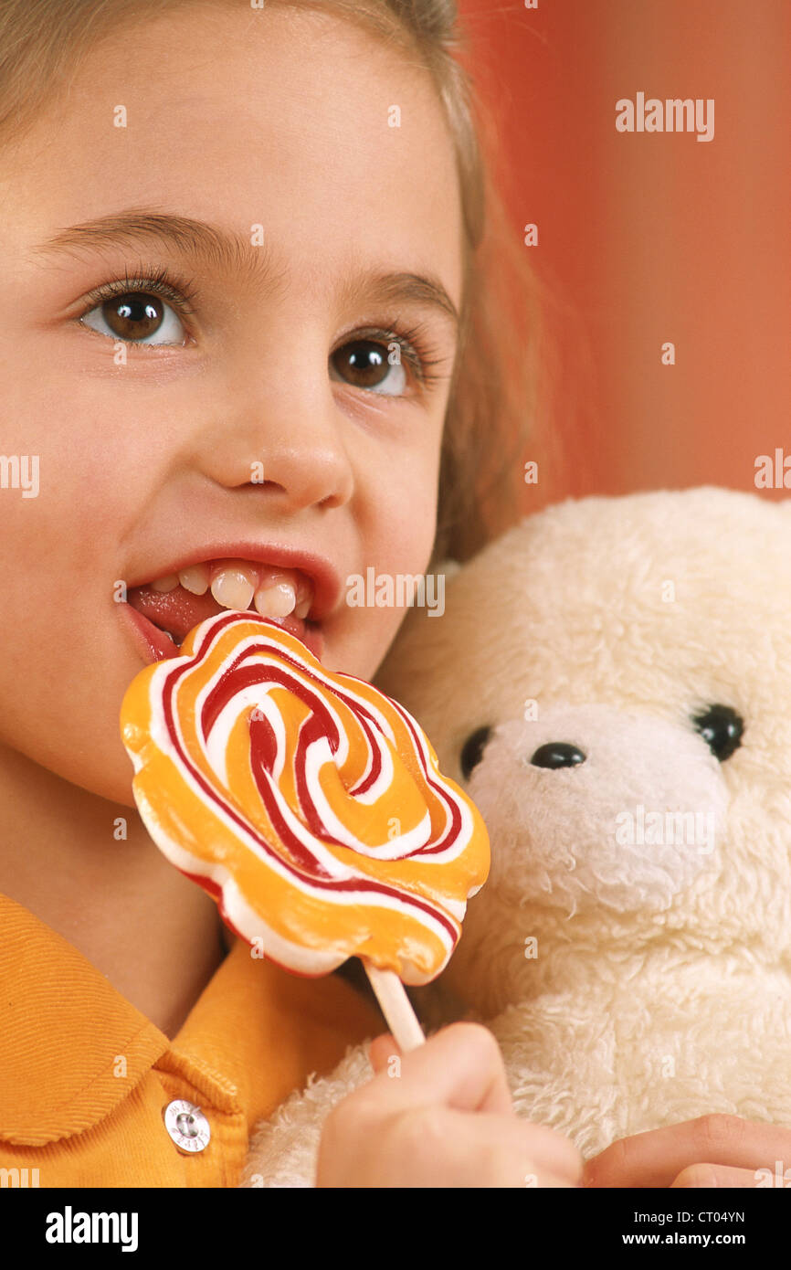 CHILD EATING SWEETS Stock Photo - Alamy