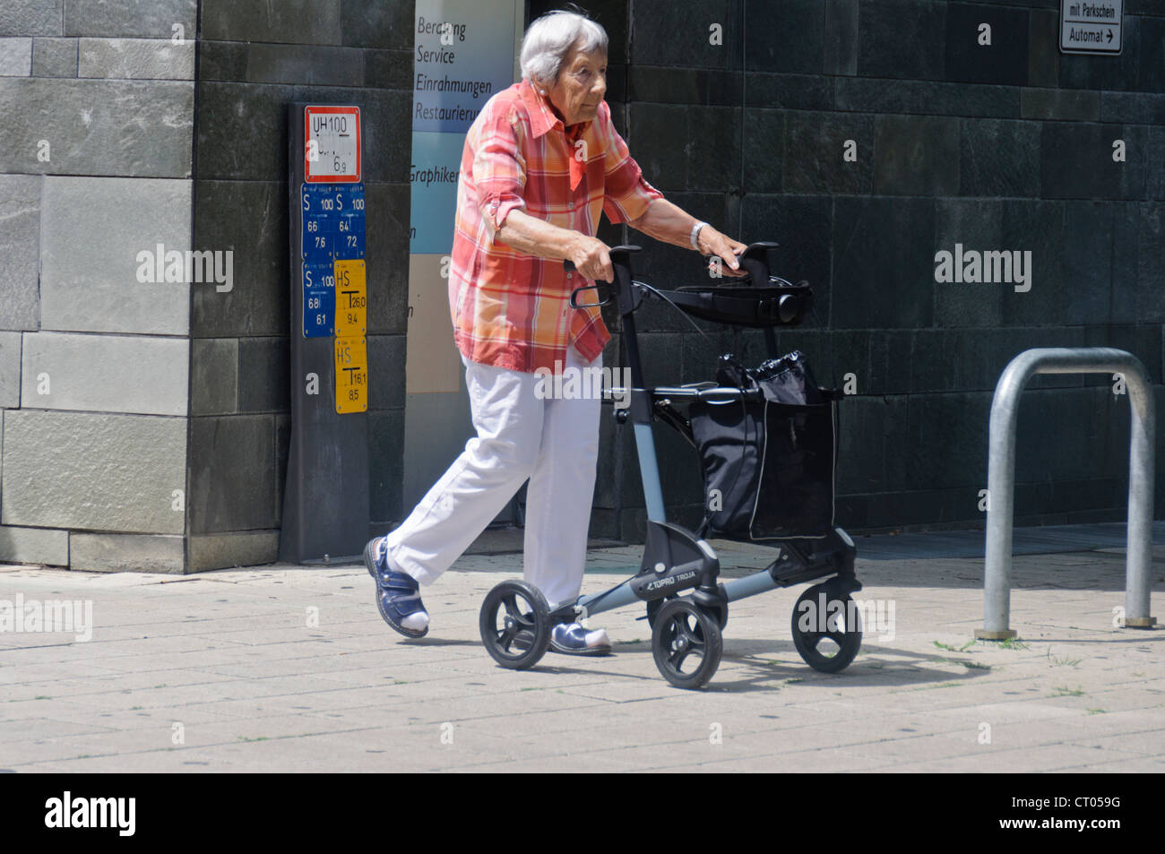 Very Old Handicapped Caucasian Woman Senior Citizen walks with Rollator ...
