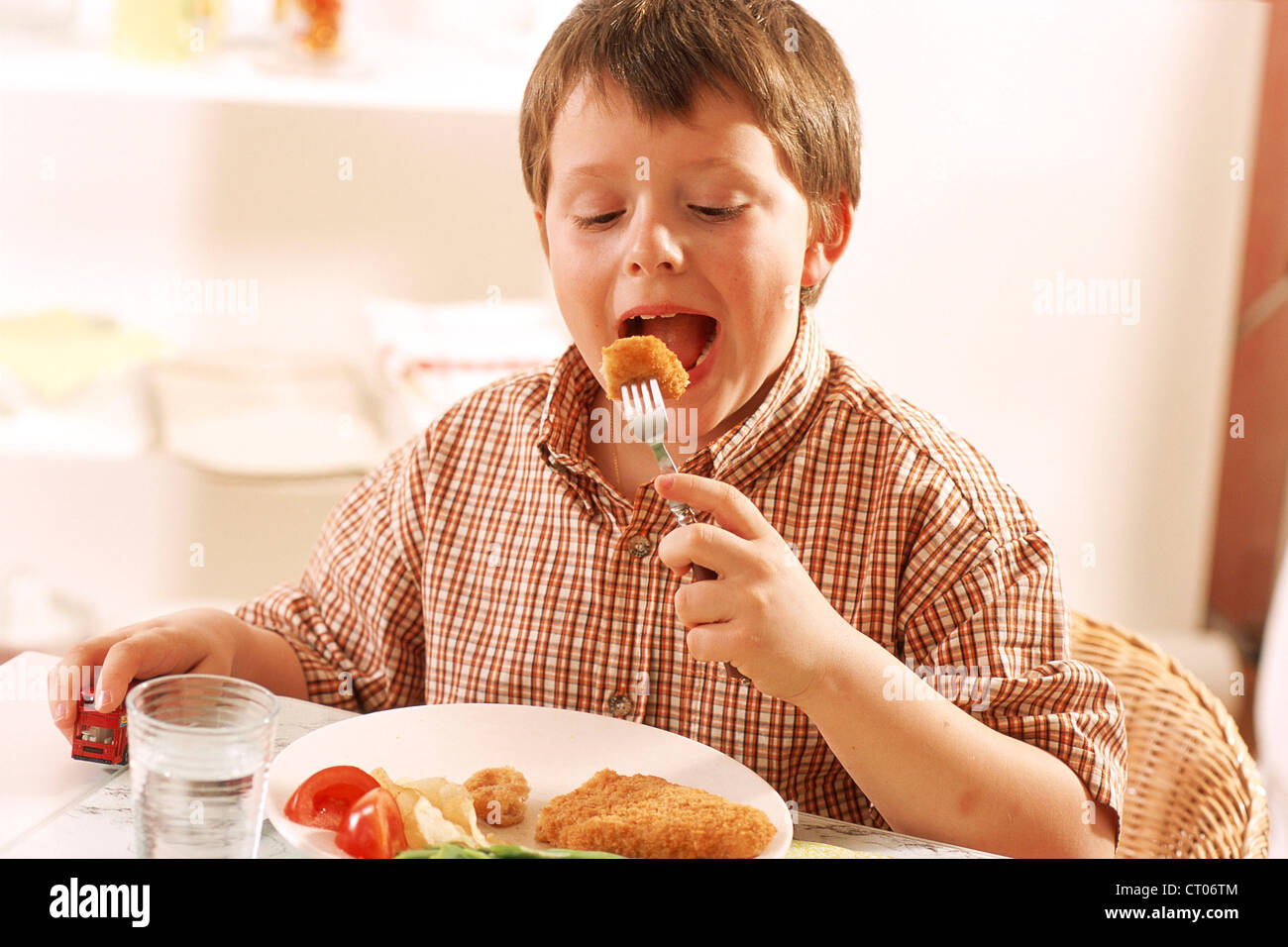 CHILD EATING FISH Stock Photo - Alamy