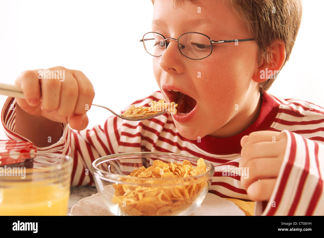 CHILD EATING BREAKFAST Stock Photo - Alamy