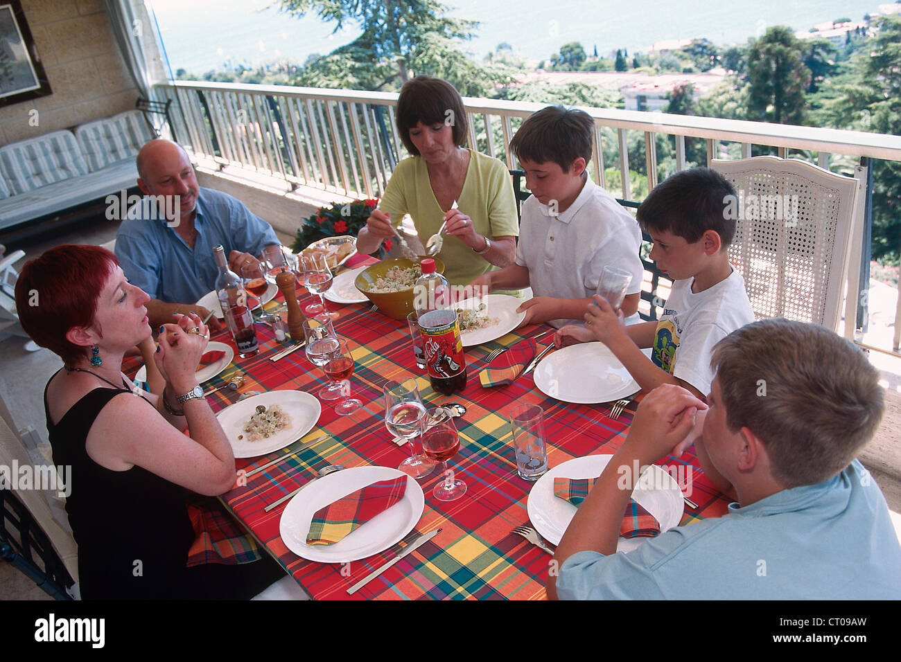 FAMILY EATING A MEAL Stock Photo - Alamy