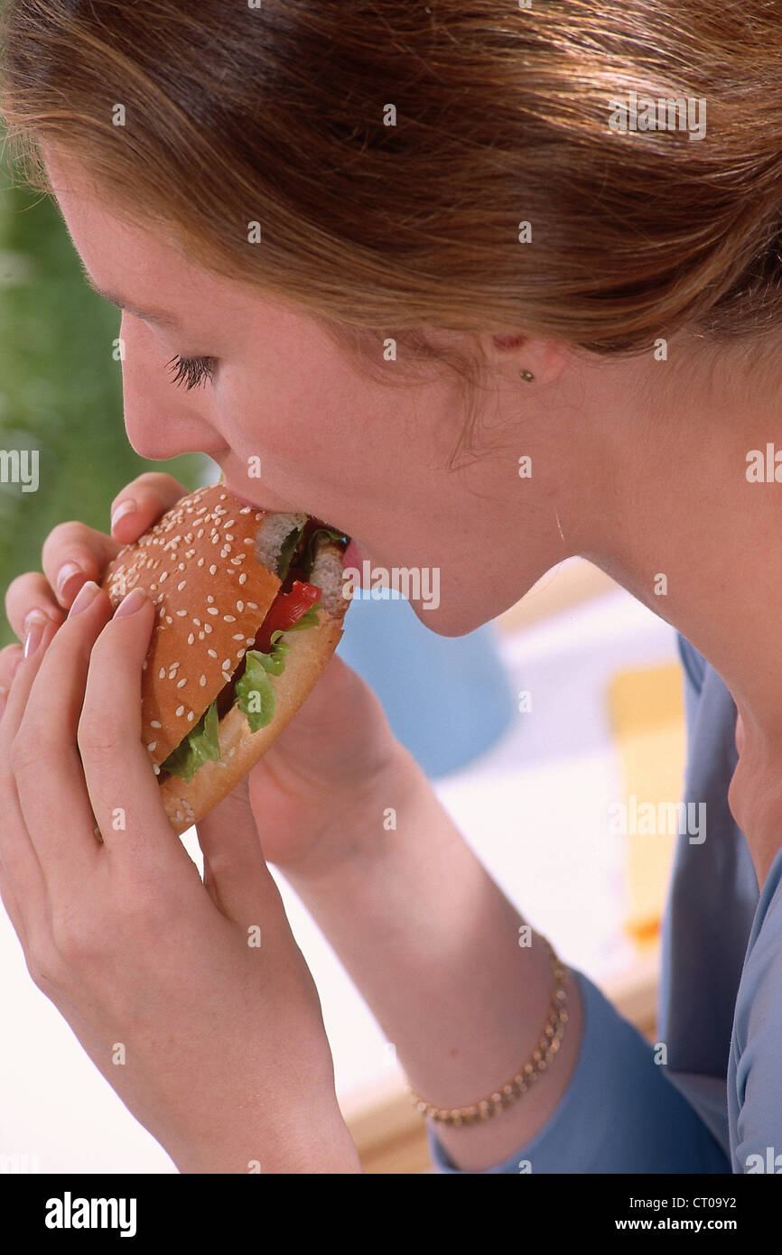 WOMAN EATING A SANDWICH Stock Photo - Alamy