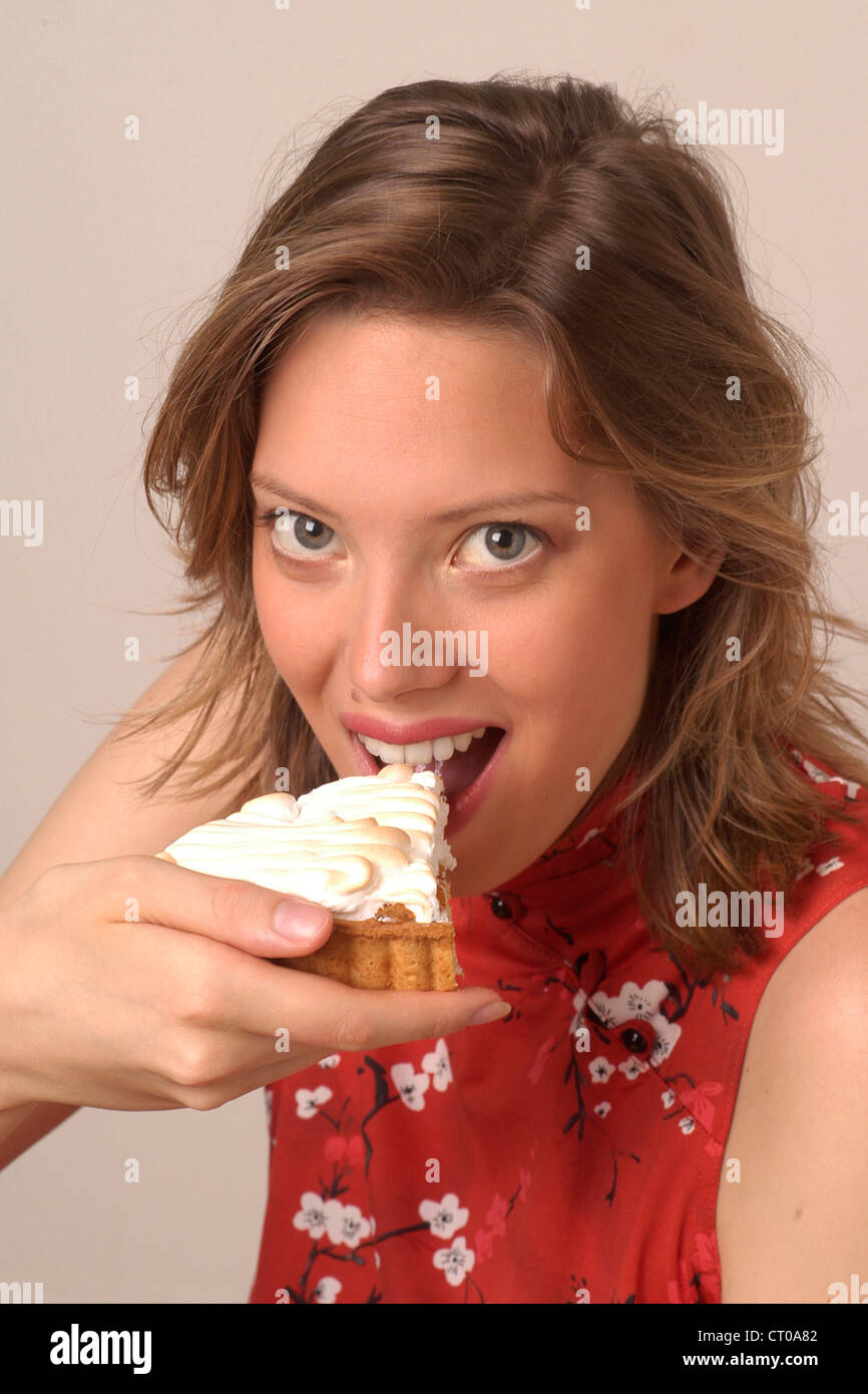 WOMAN EATING SWEETS Stock Photo - Alamy