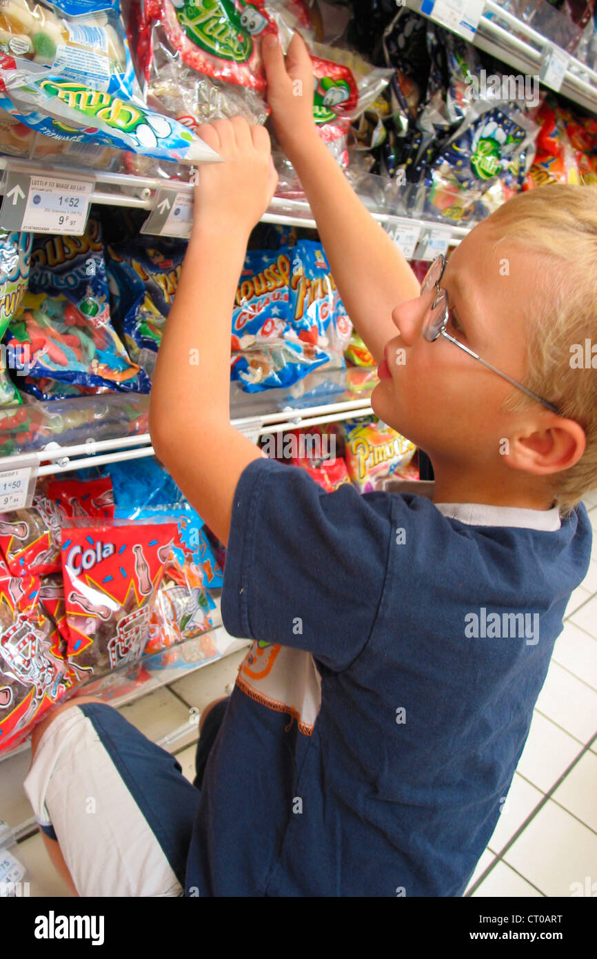 CHILD EATING SWEETS Stock Photo - Alamy