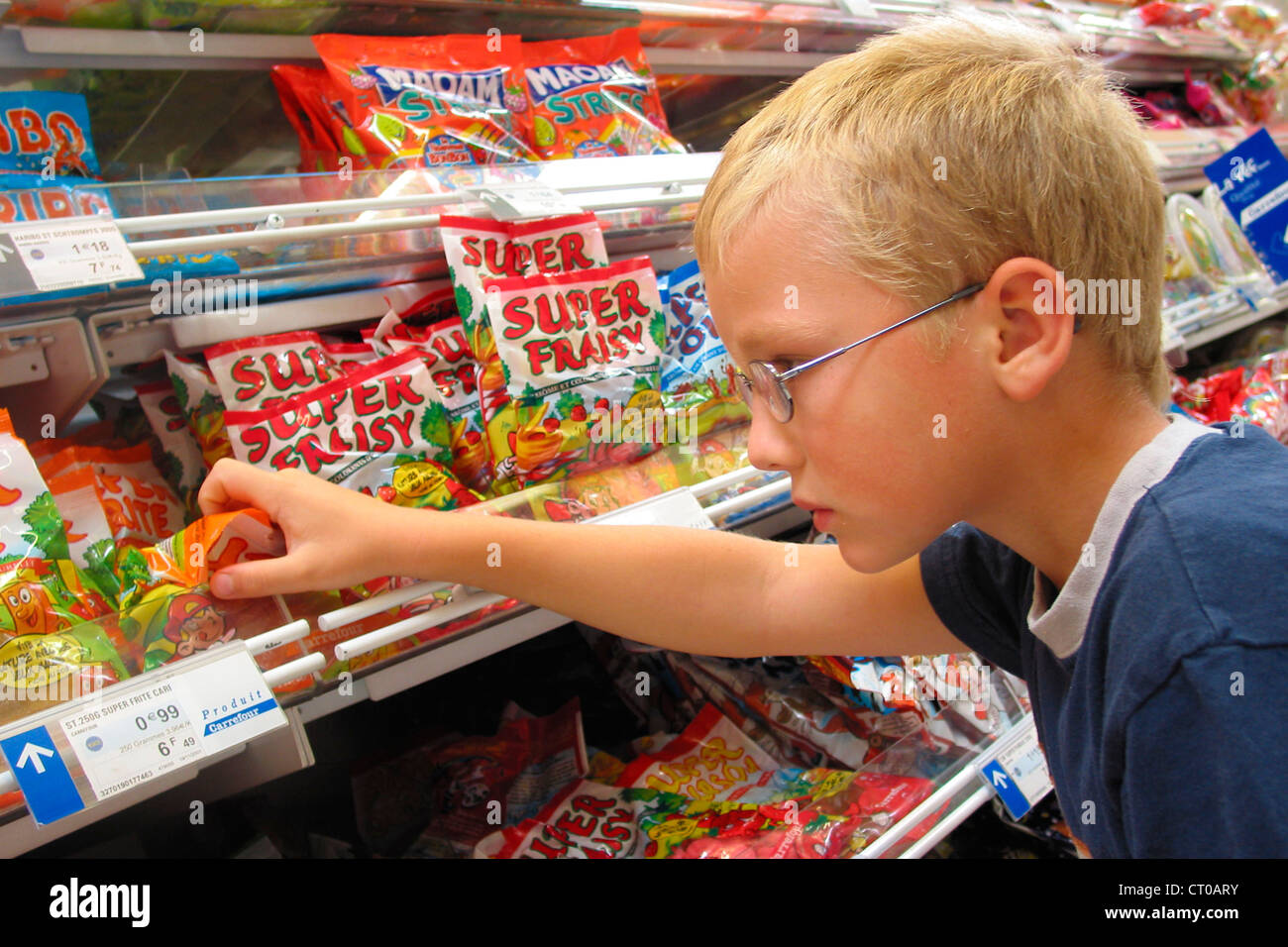 CHILD EATING SWEETS Stock Photo - Alamy