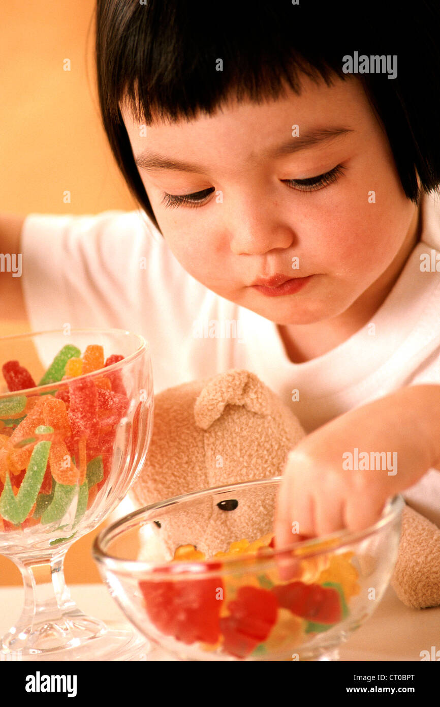 CHILD EATING SWEETS Stock Photo - Alamy