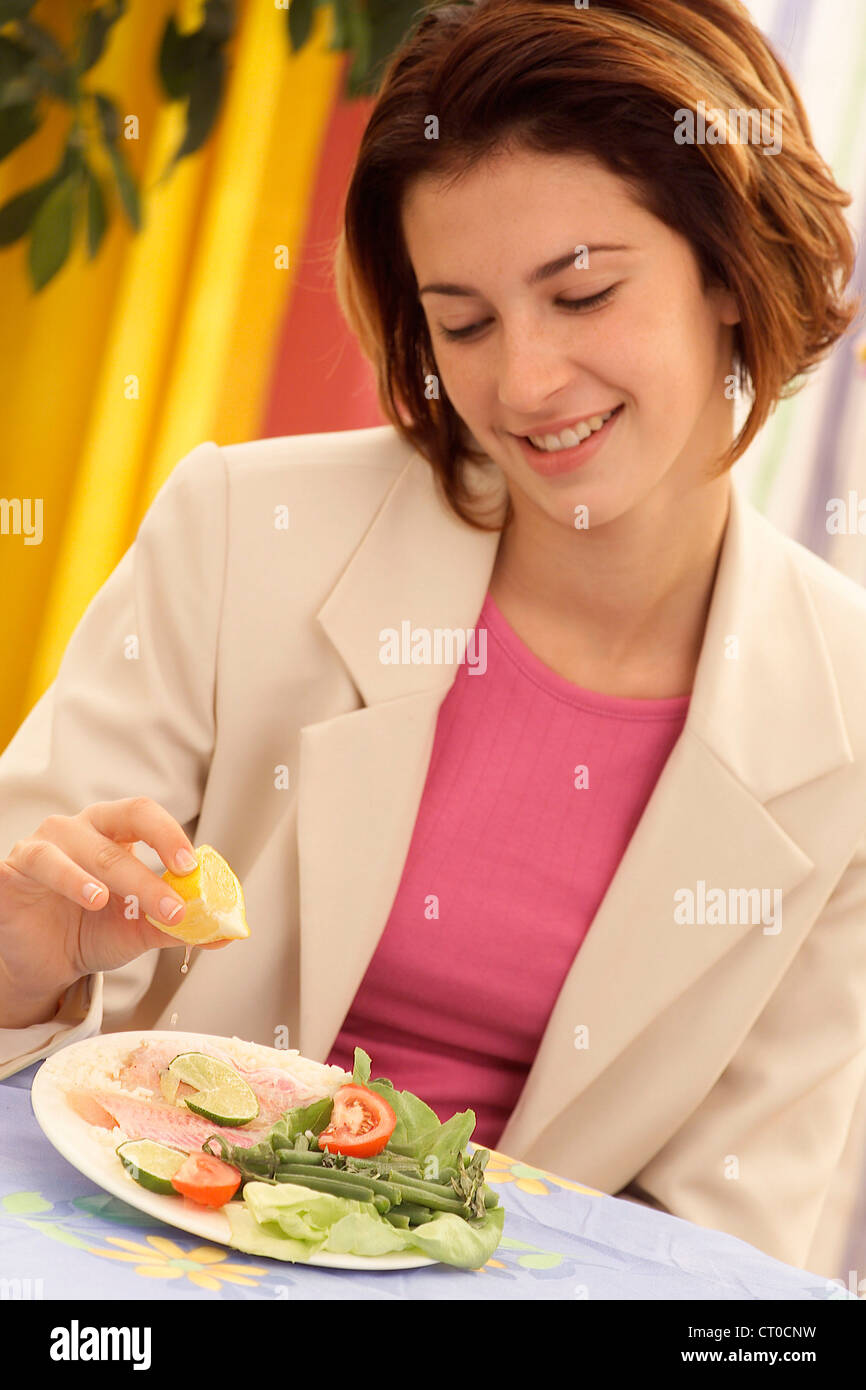 WOMAN EATING FISH Stock Photo - Alamy