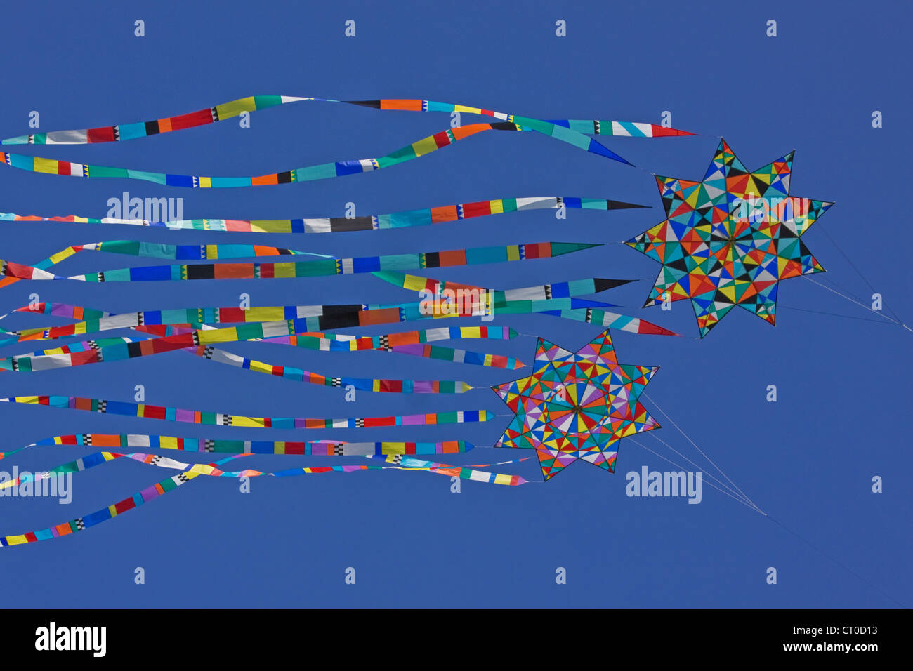 Brightly colored kites riding high on the breeze Stock Photo - Alamy