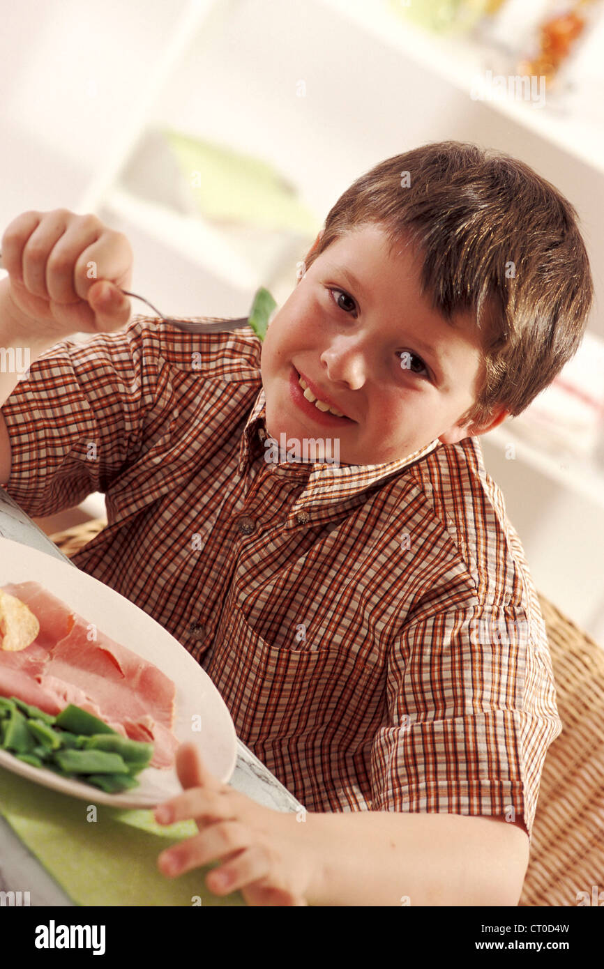 CHILD EATING MEAT Stock Photo - Alamy