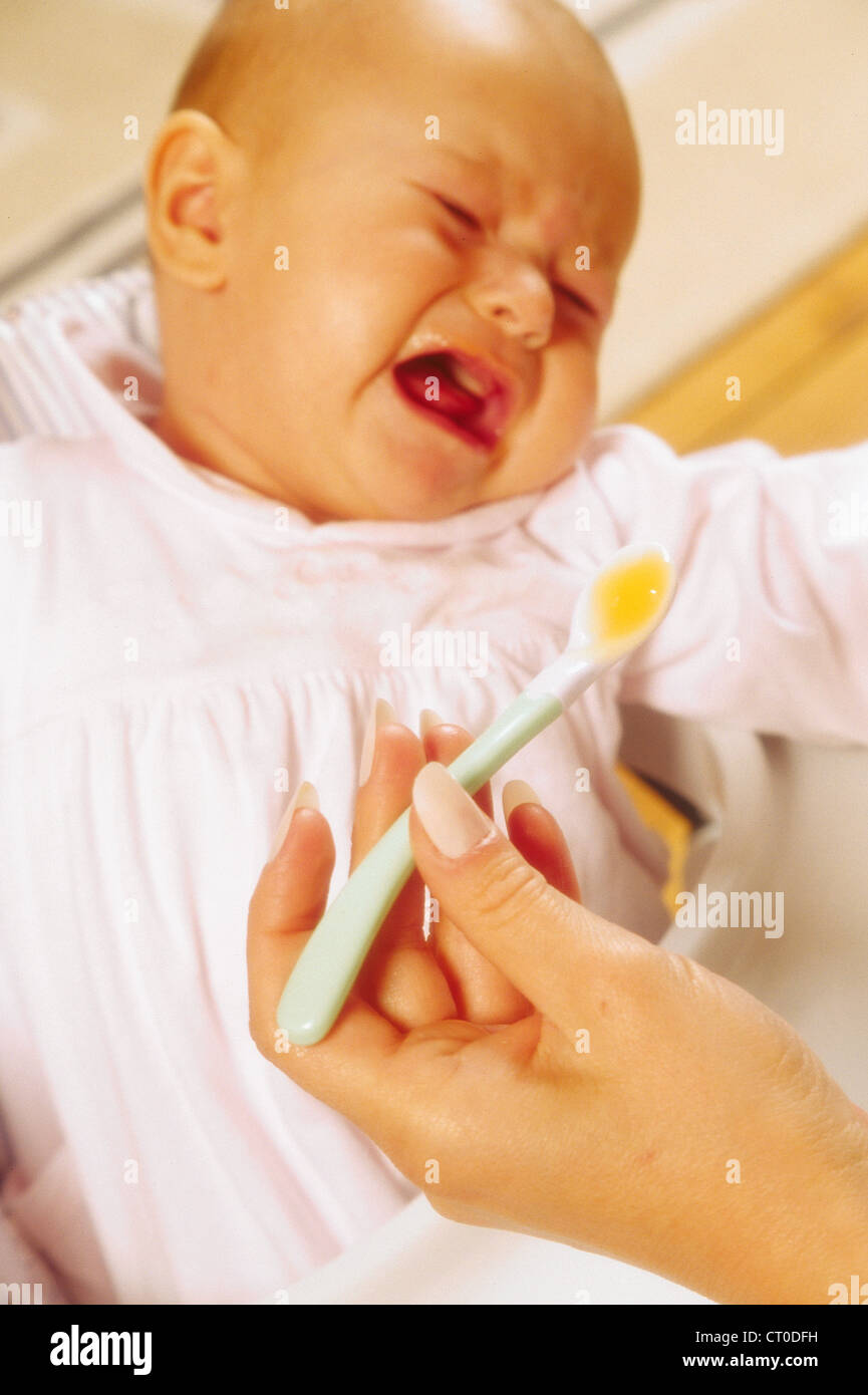 Baby unhappy eating hi-res stock photography and images - Alamy