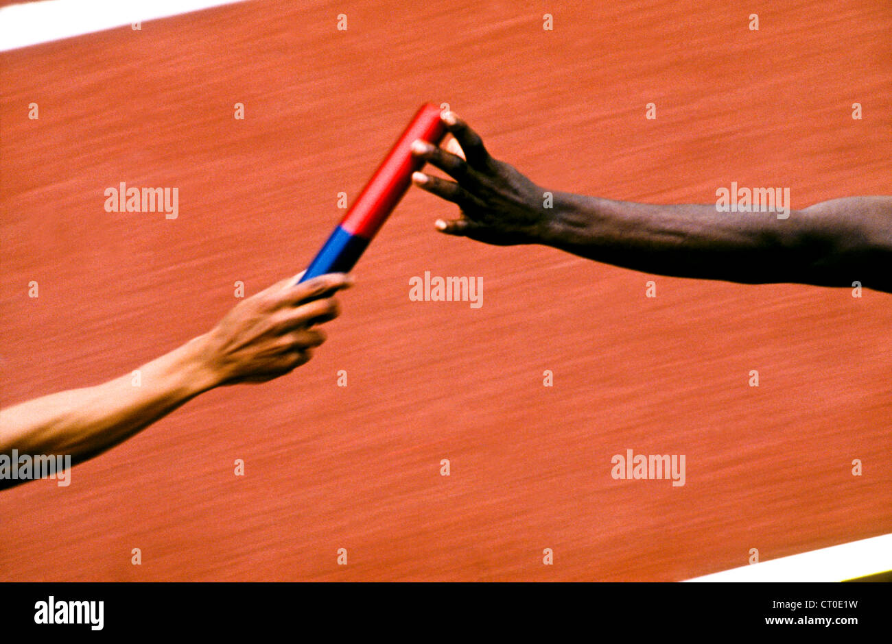Detail of track and field relay baton pass Stock Photo - Alamy