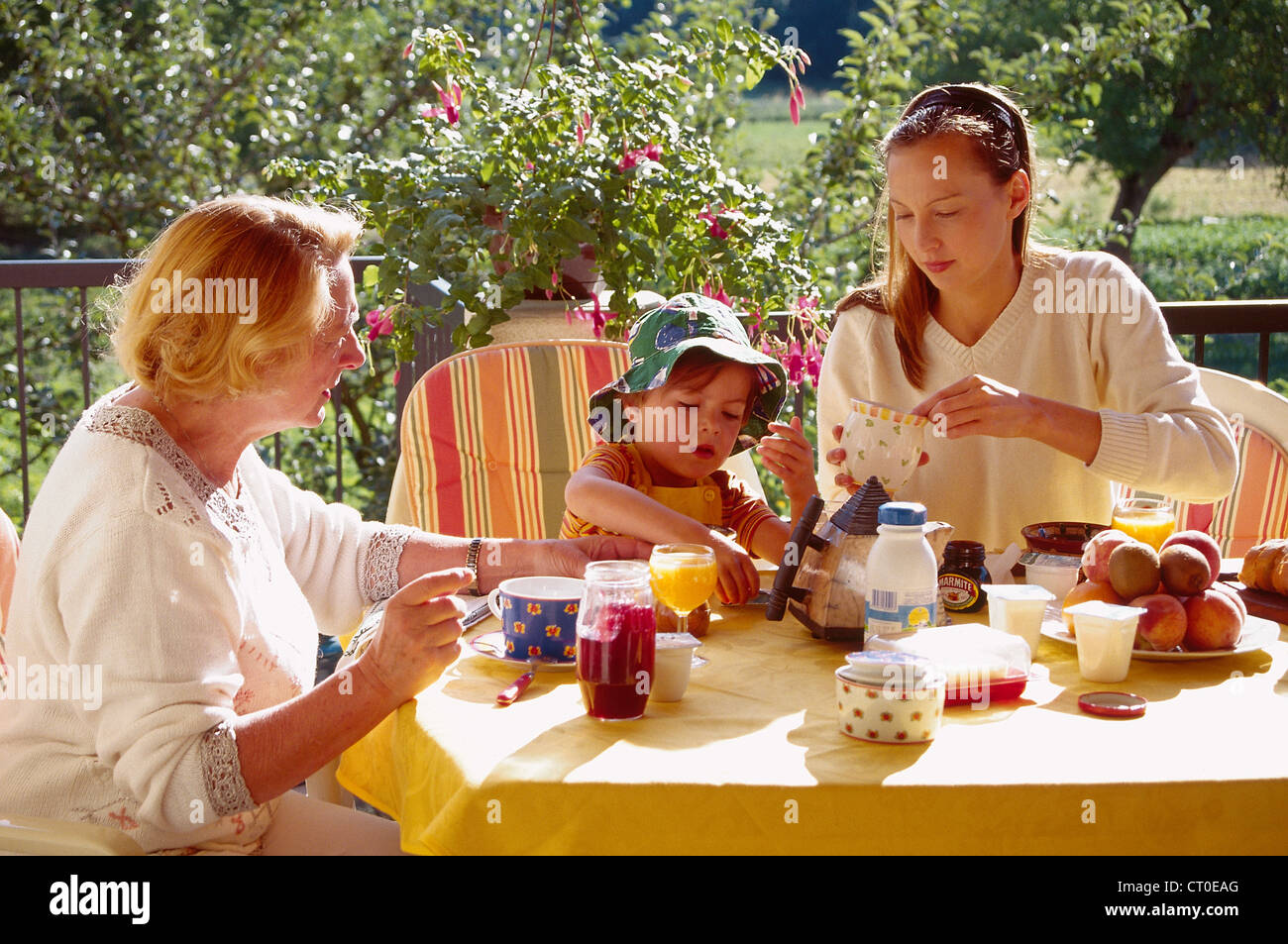 Mature woman eating breakfast outdoor hi-res stock photography and ...