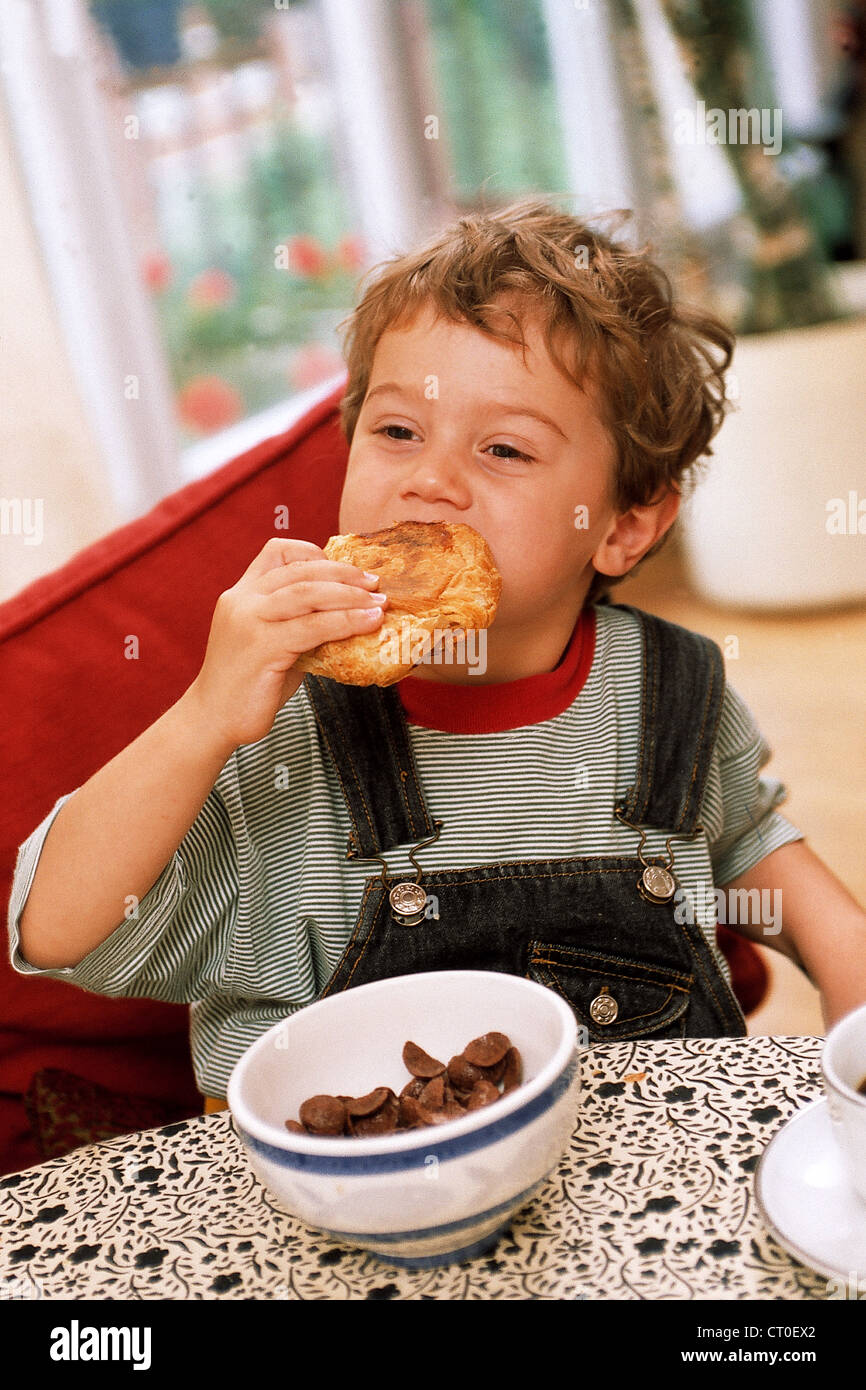 CHILD EATING BREAKFAST Stock Photo - Alamy