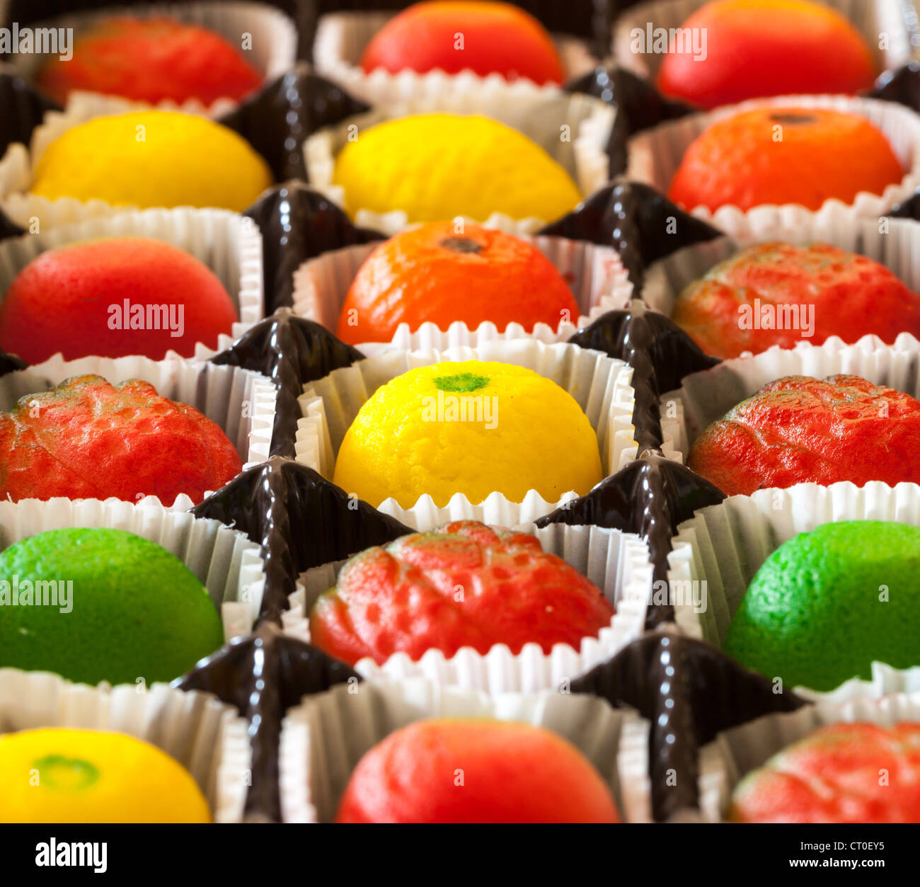 Fruit shaped candies in macro image of marzipan sweets in paper ...