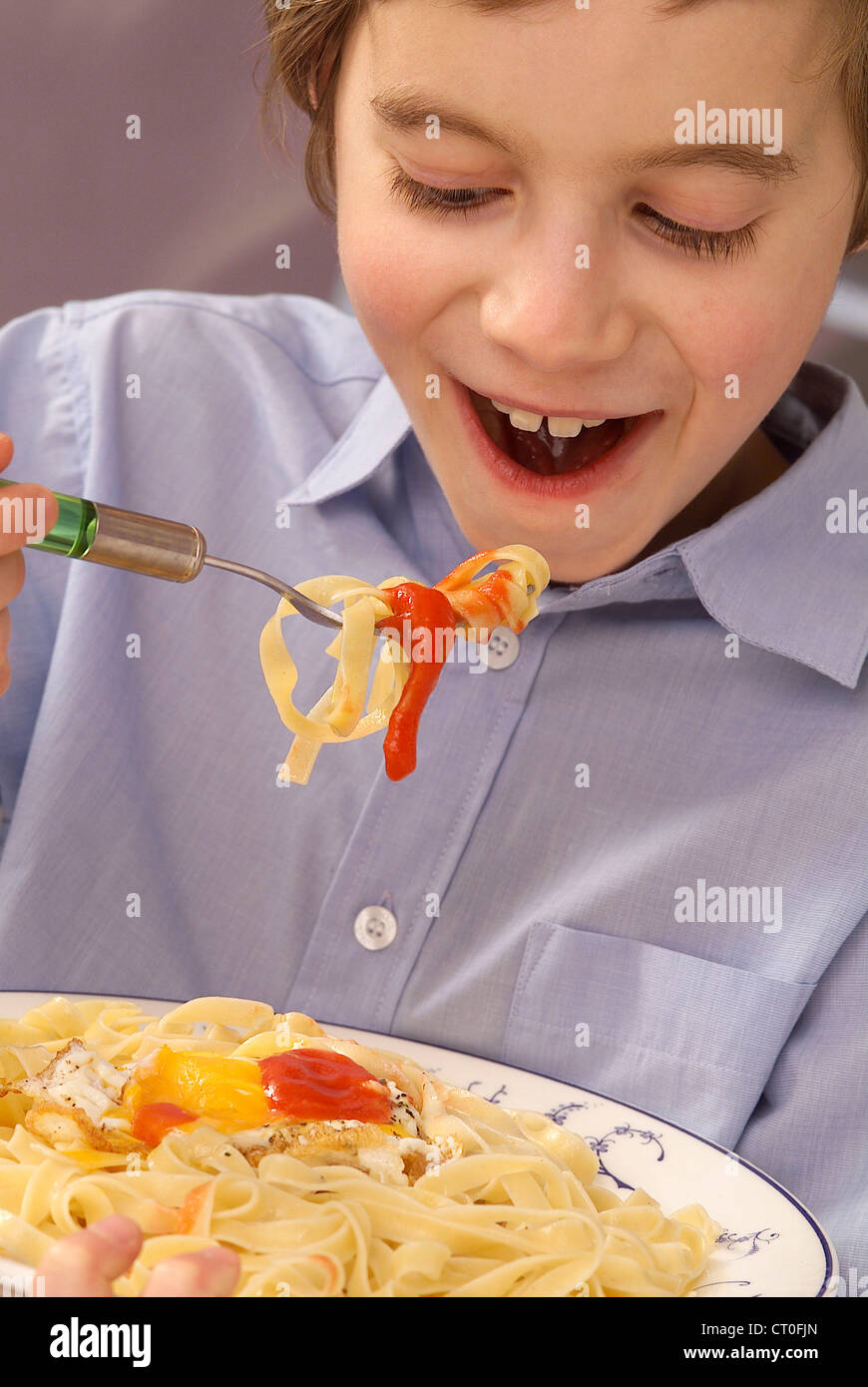CHILD EATING STARCHY FOOD Stock Photo - Alamy