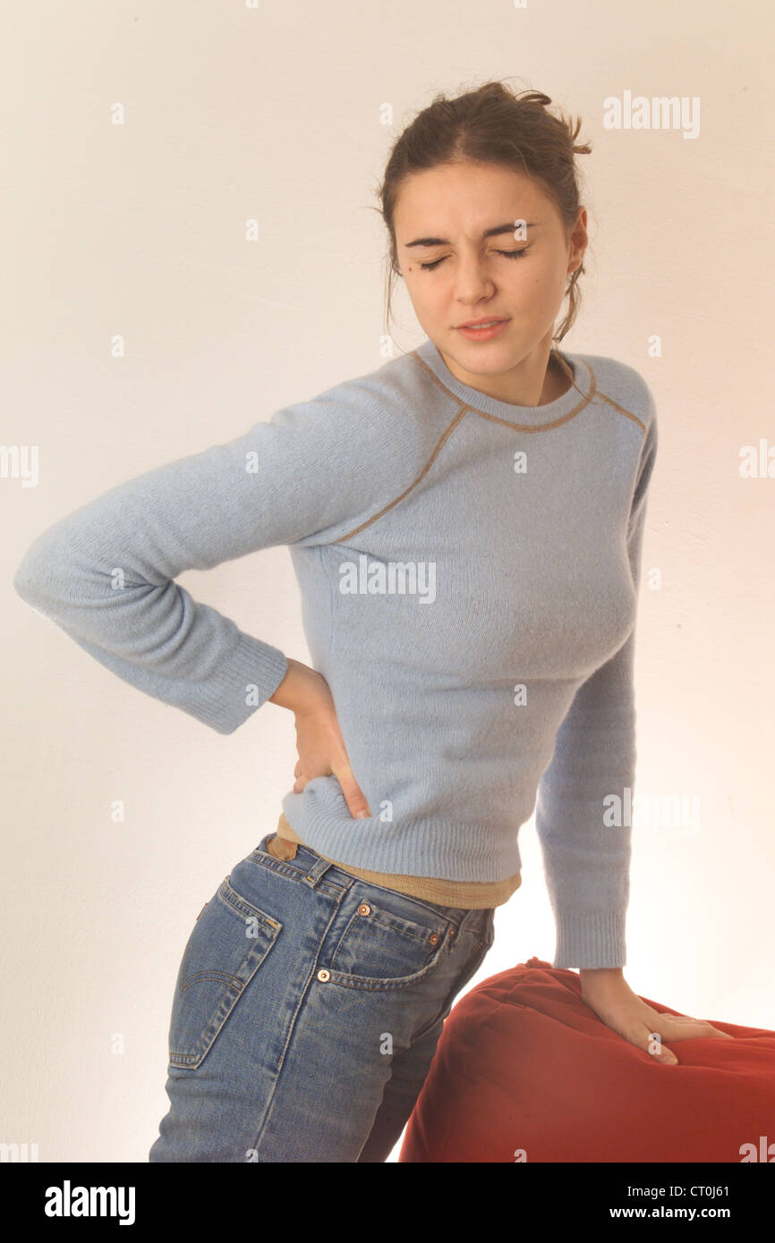 BACK PAIN IN A WOMAN Stock Photo - Alamy