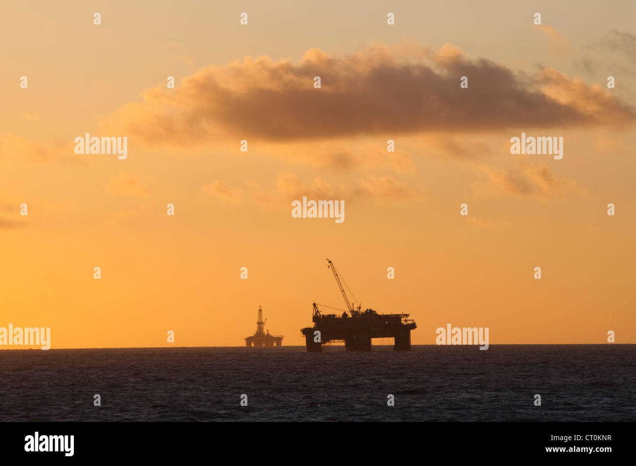 silhouette of some oil rigs in offshore oil field. Campos Basin, Brazil ...