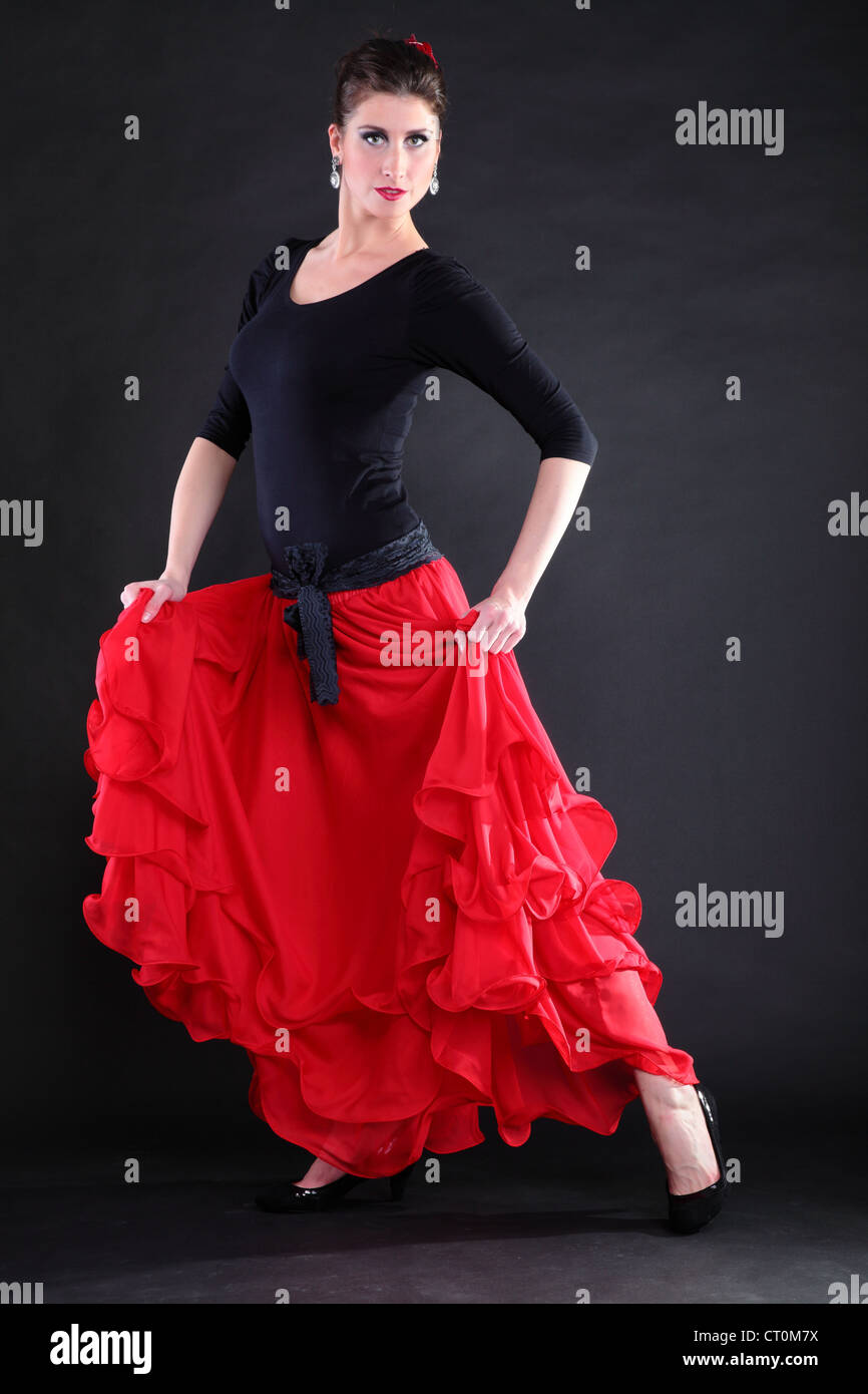 Attractive spanish dancer over black background young woman dancing ...