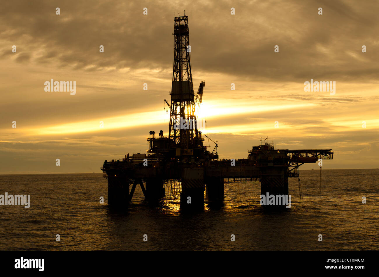 silhouette of offshore oil drilling rig in sunset/sunrise time. Coast ...
