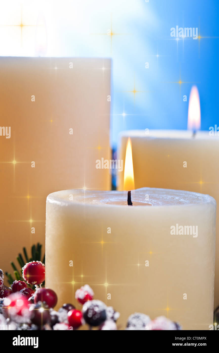 Three candles in an advent flower arrangement for advent and Christmas ...
