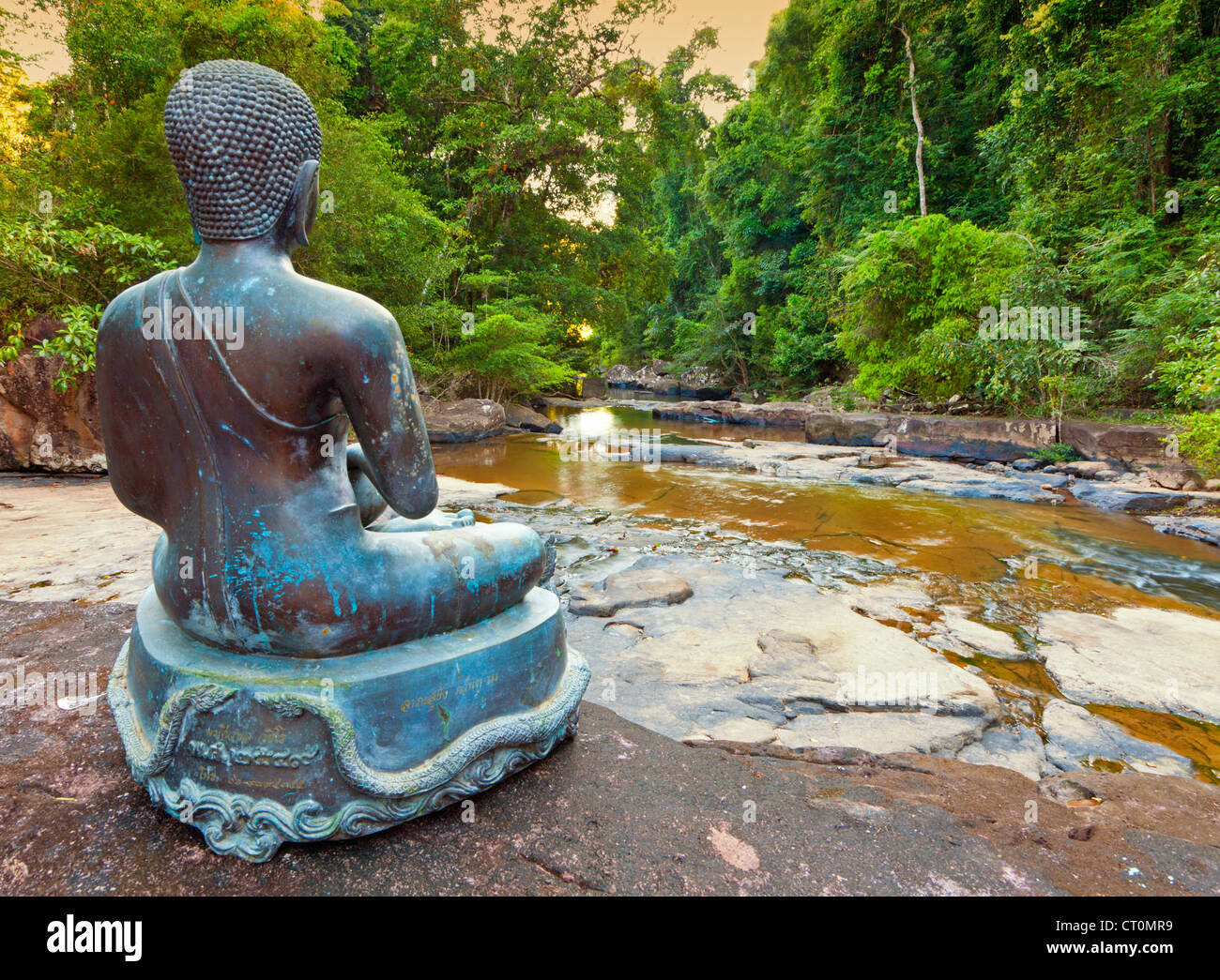 Statue of the Buddha by a jungle stream Stock Photo - Alamy