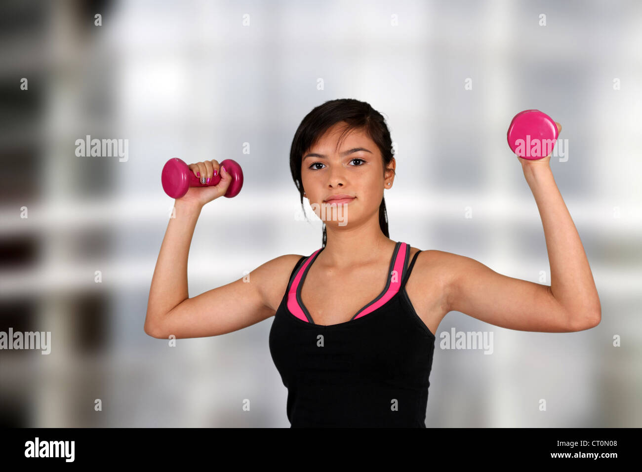 Teen girl working out in the gym Stock Photo - Alamy