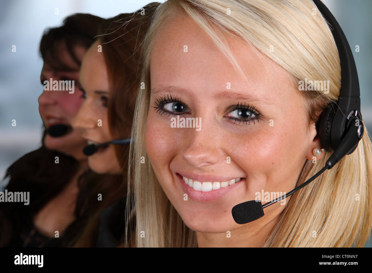 Young women giving help as customer service employees Stock Photo - Alamy