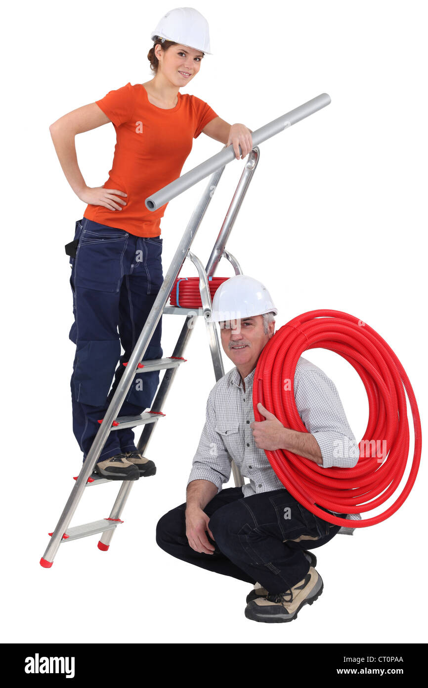 two plumbers working together Stock Photo - Alamy