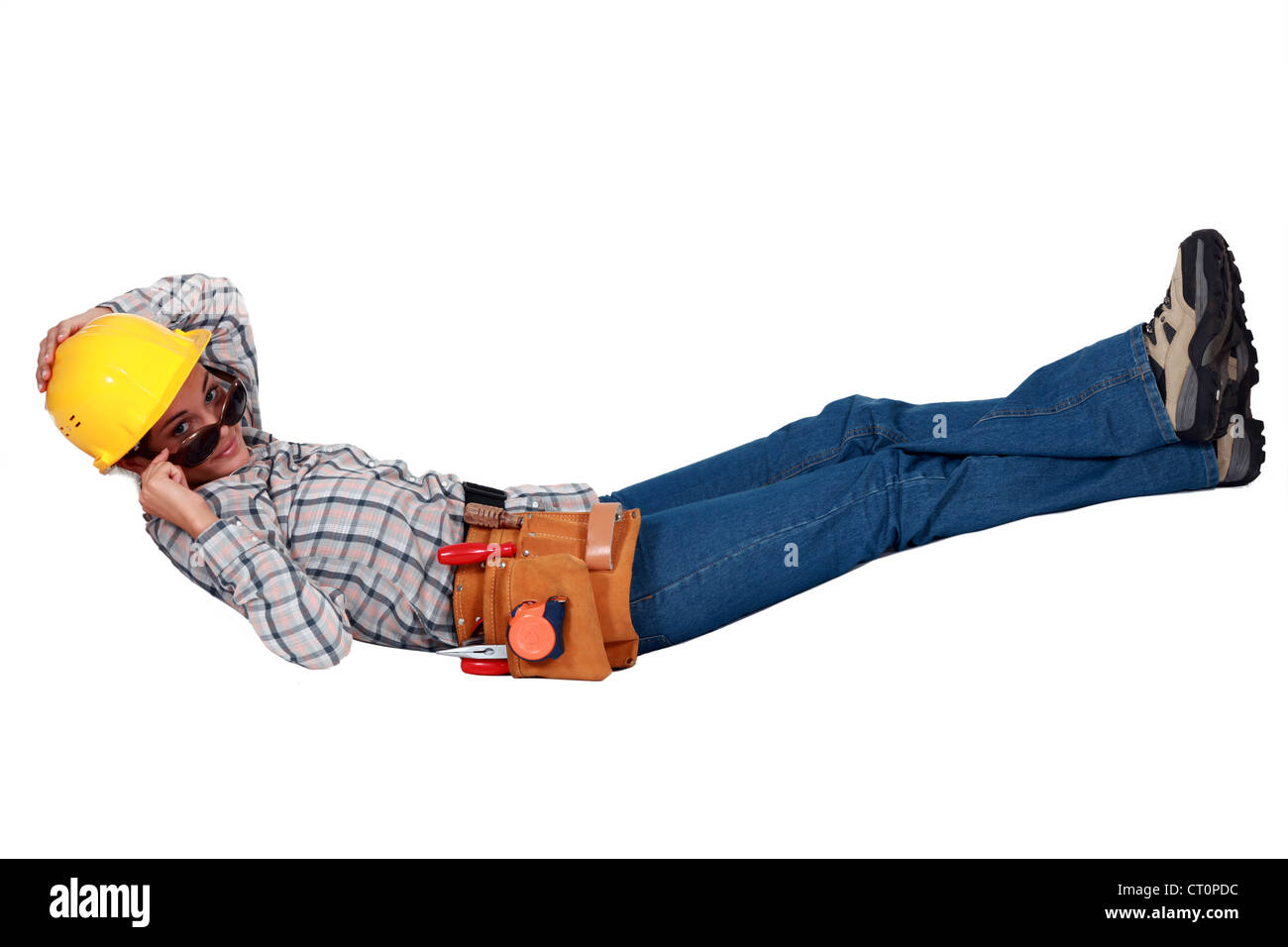 Female builder in sunglasses laying down Stock Photo - Alamy